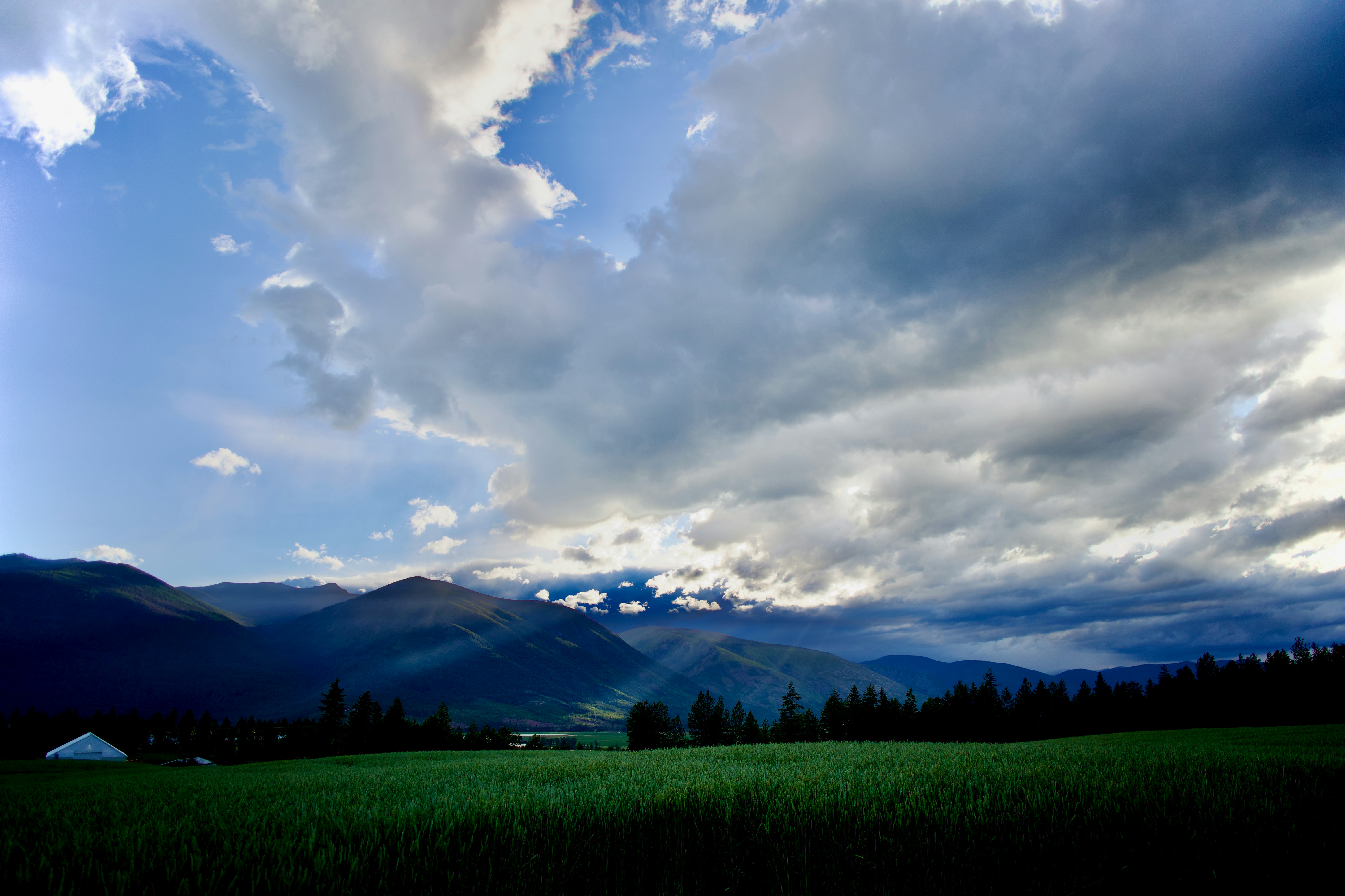 Shaded Valleys Under a Crest of Clouds