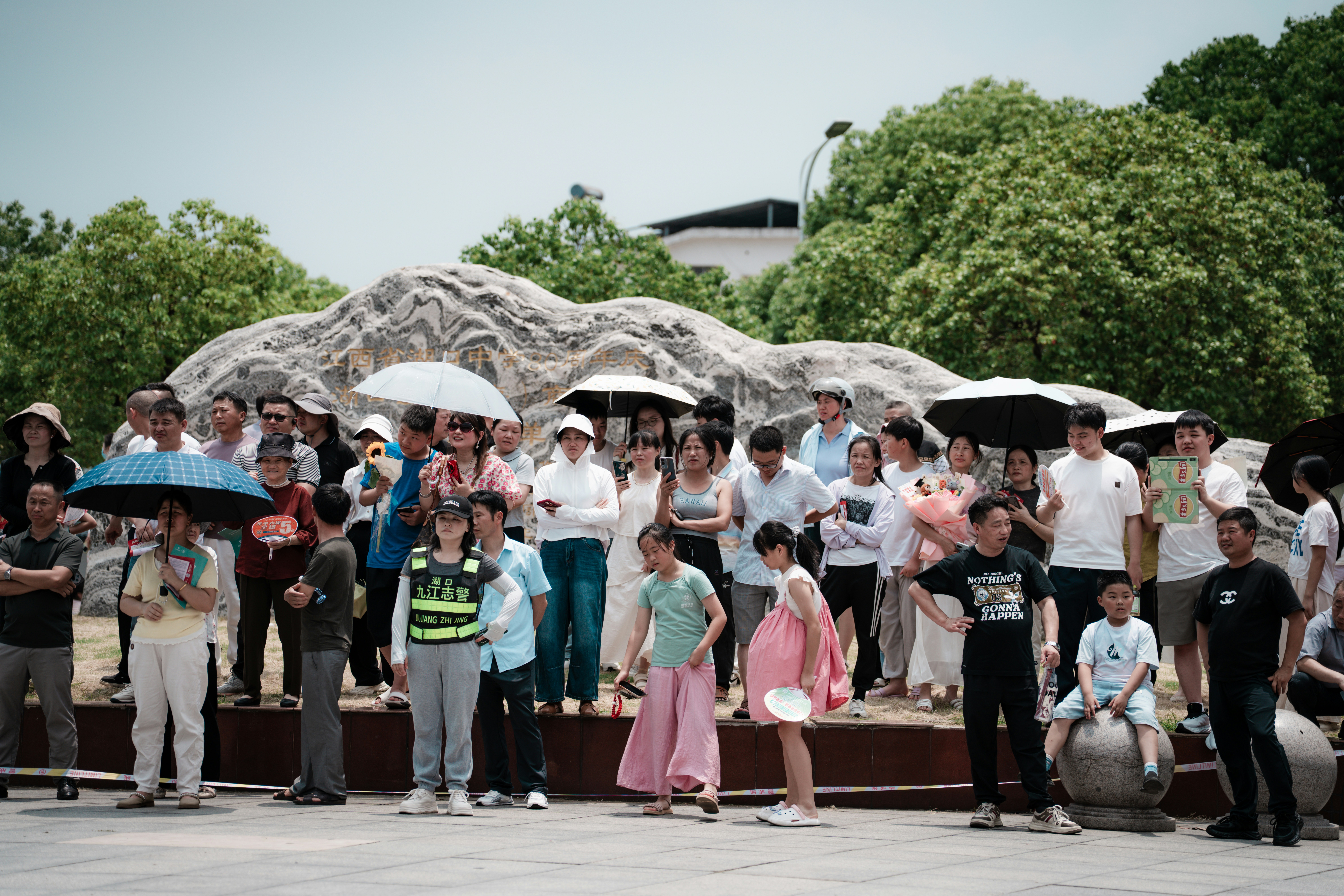 Crowd Under Stone Canopy: Capturing a Moment of Community