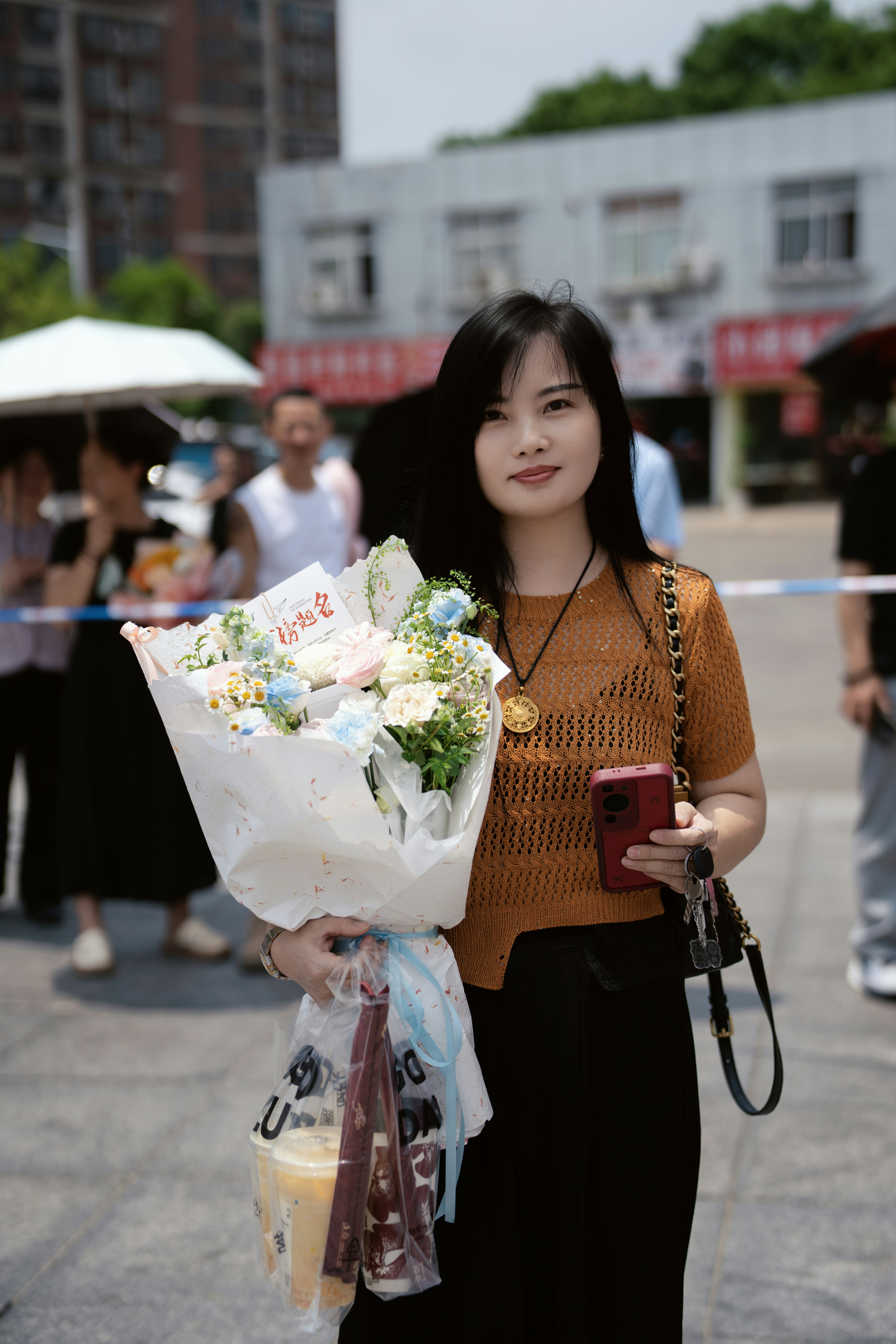 Portrait in Bloom: A bouquet and a quiet smile beyond the crowd