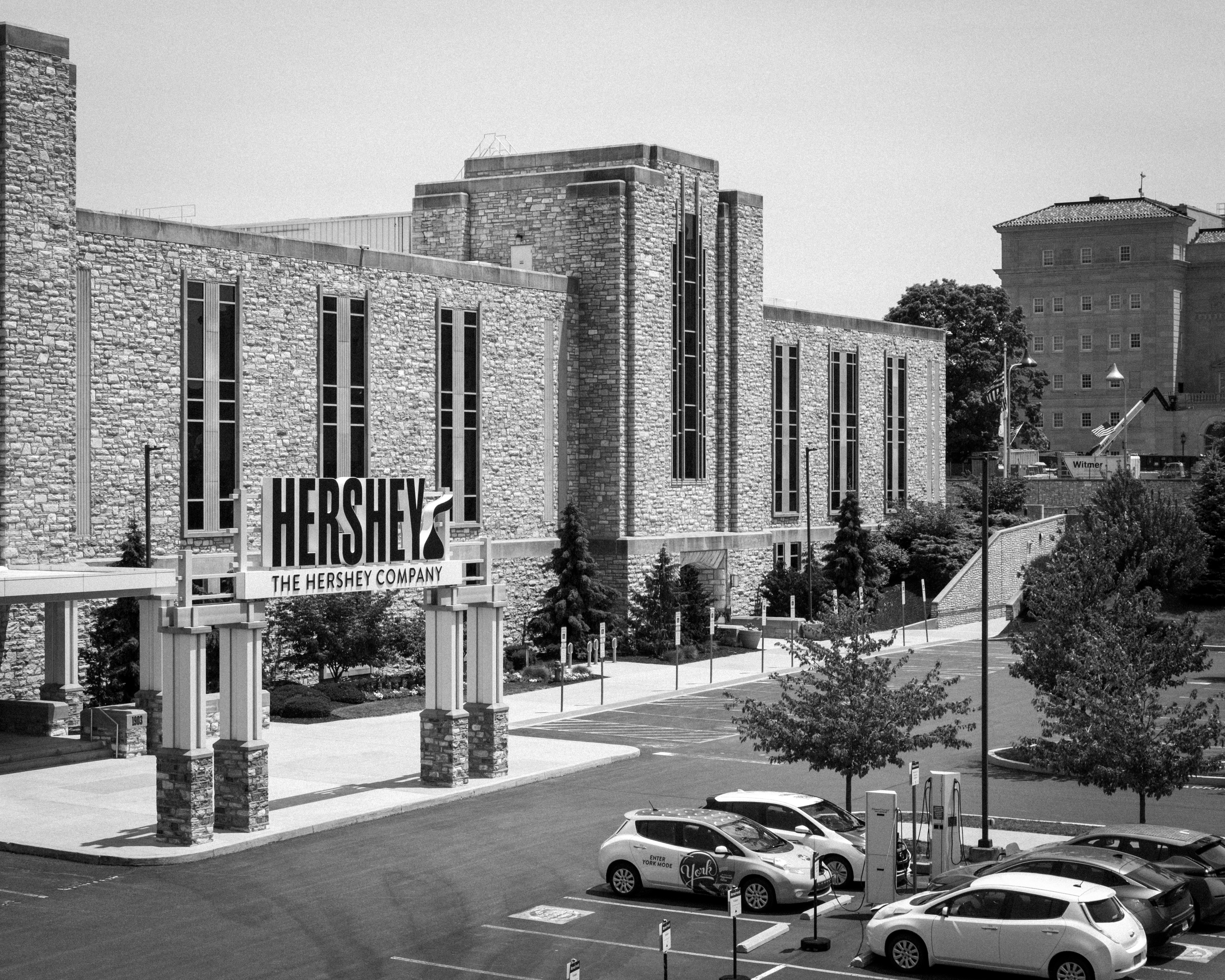 Hershey company building with a prominent sign and parking lot.