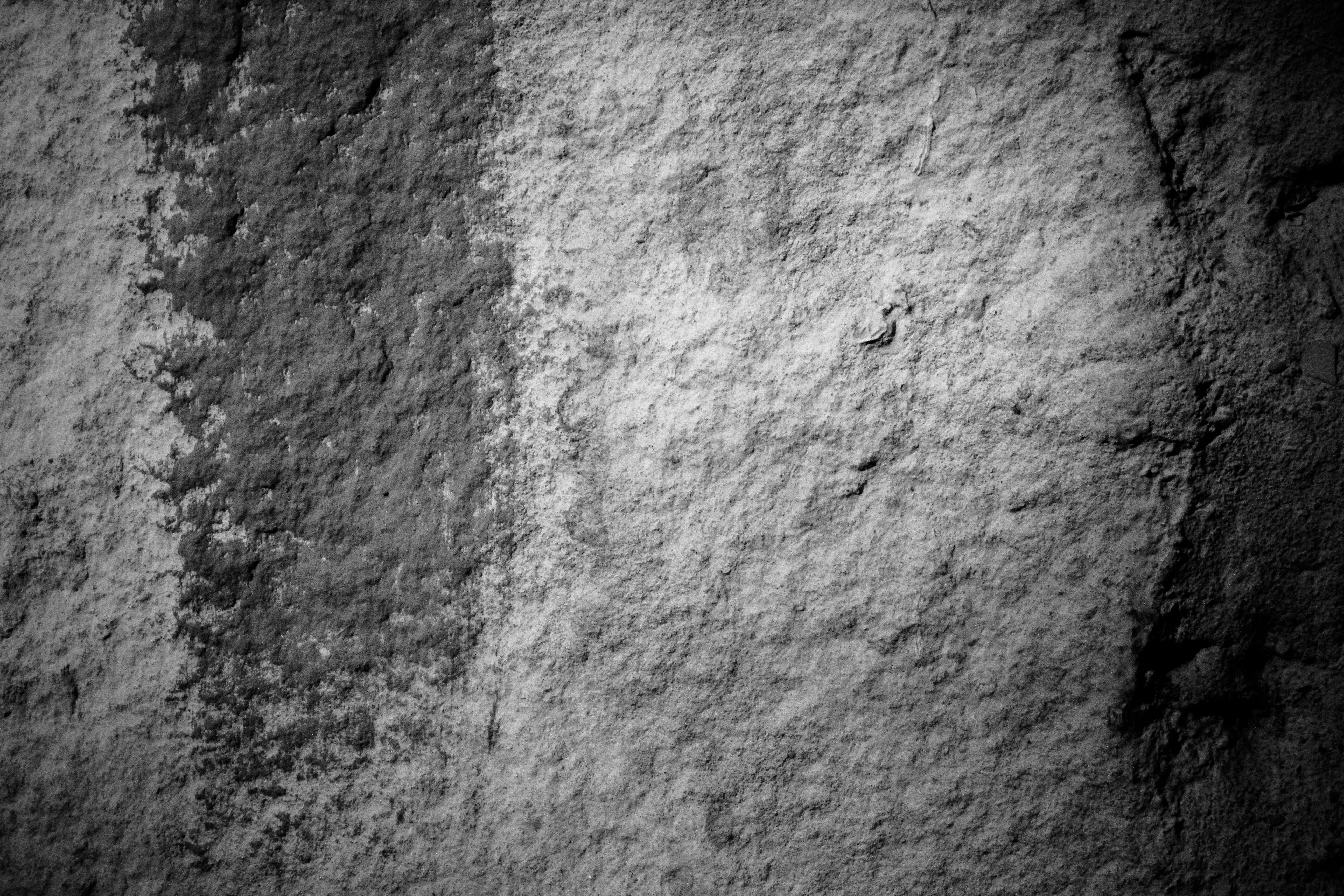 Slate-gray rock texture with varied grain and subtle light falloff, emphasizing tactile surface details and tonal range.