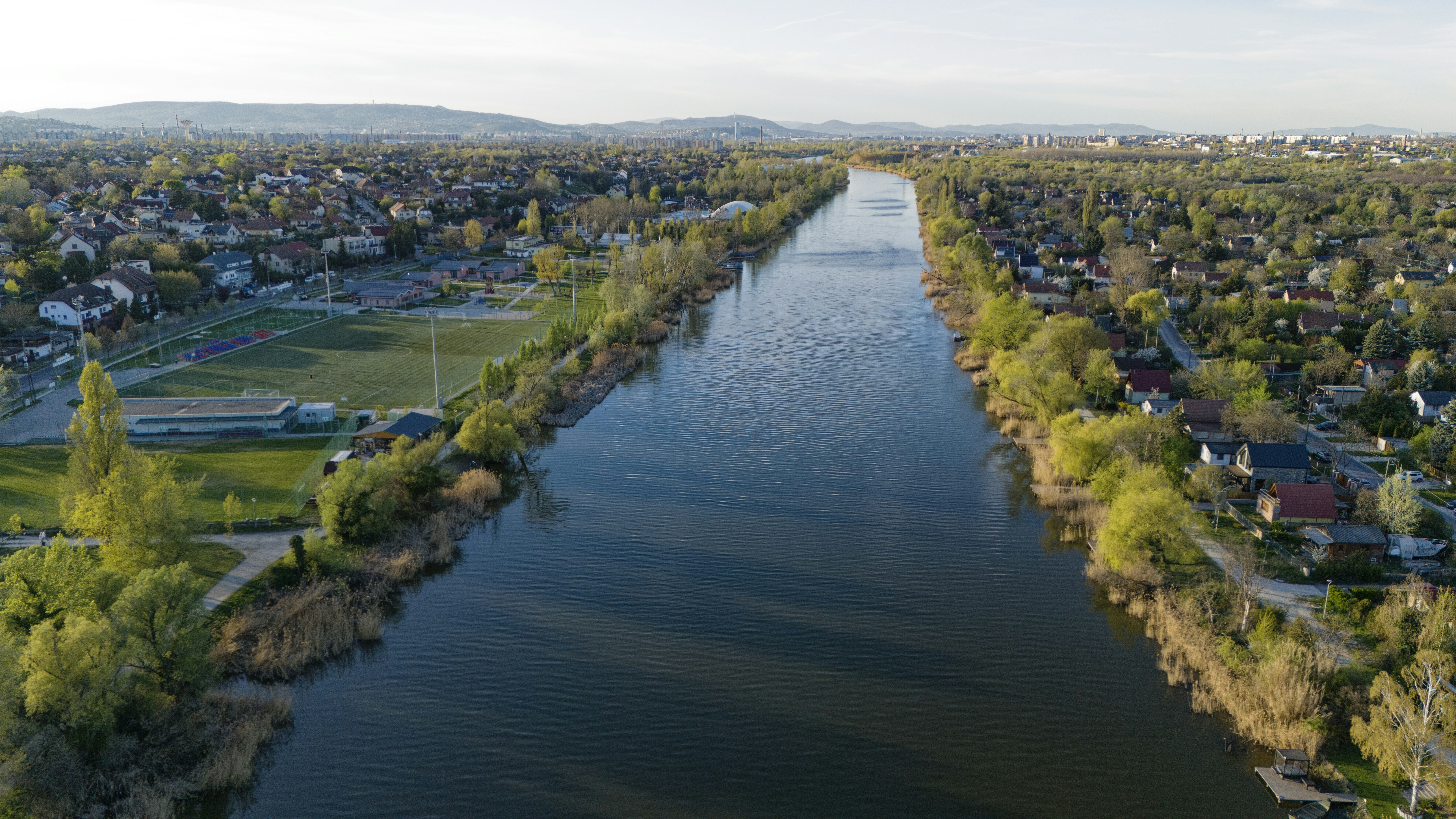 Aerial Convergence: River Lens Between Quiet Suburbs