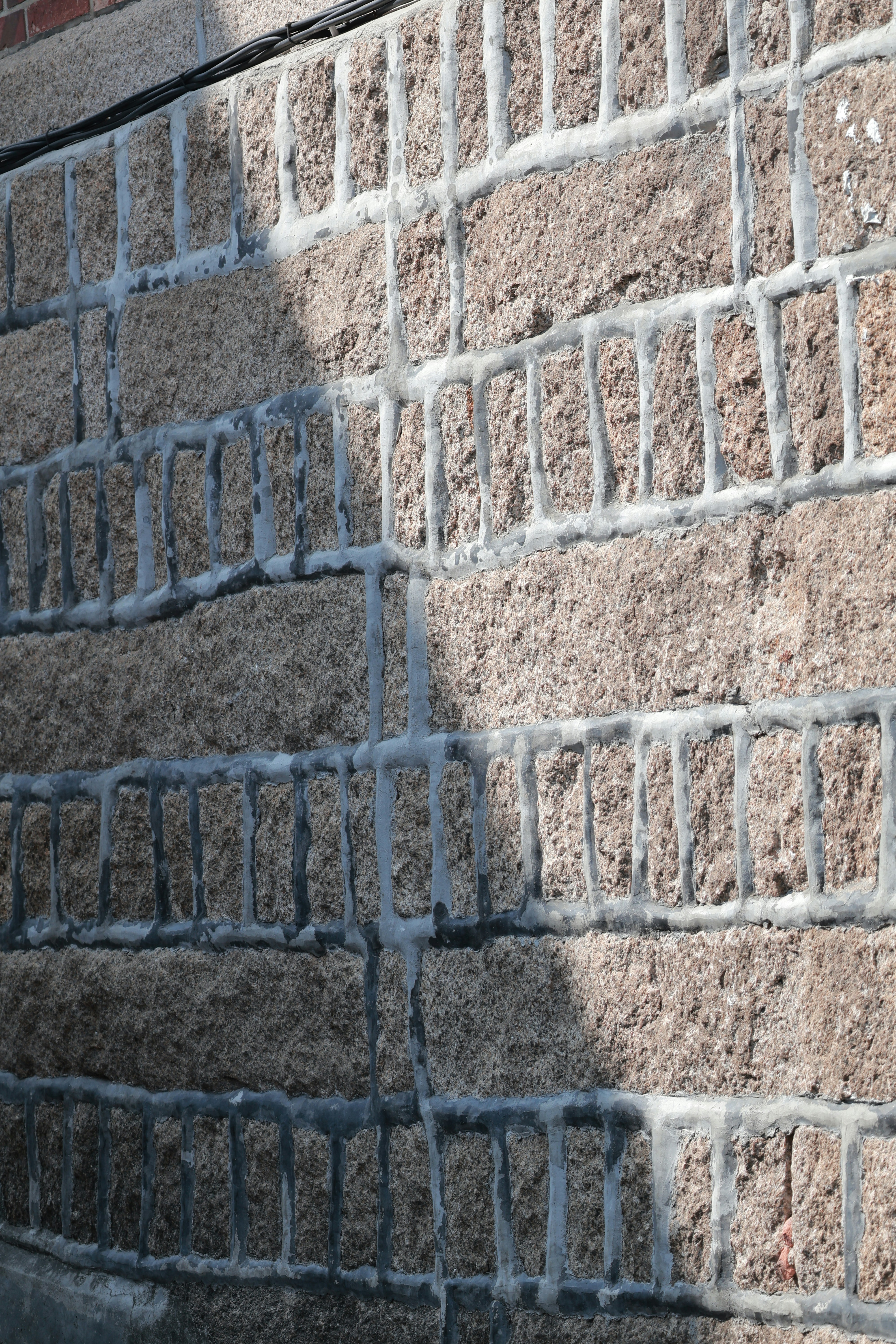 Shadowed Brickwork: A Quiet Morning on Rough Masonry