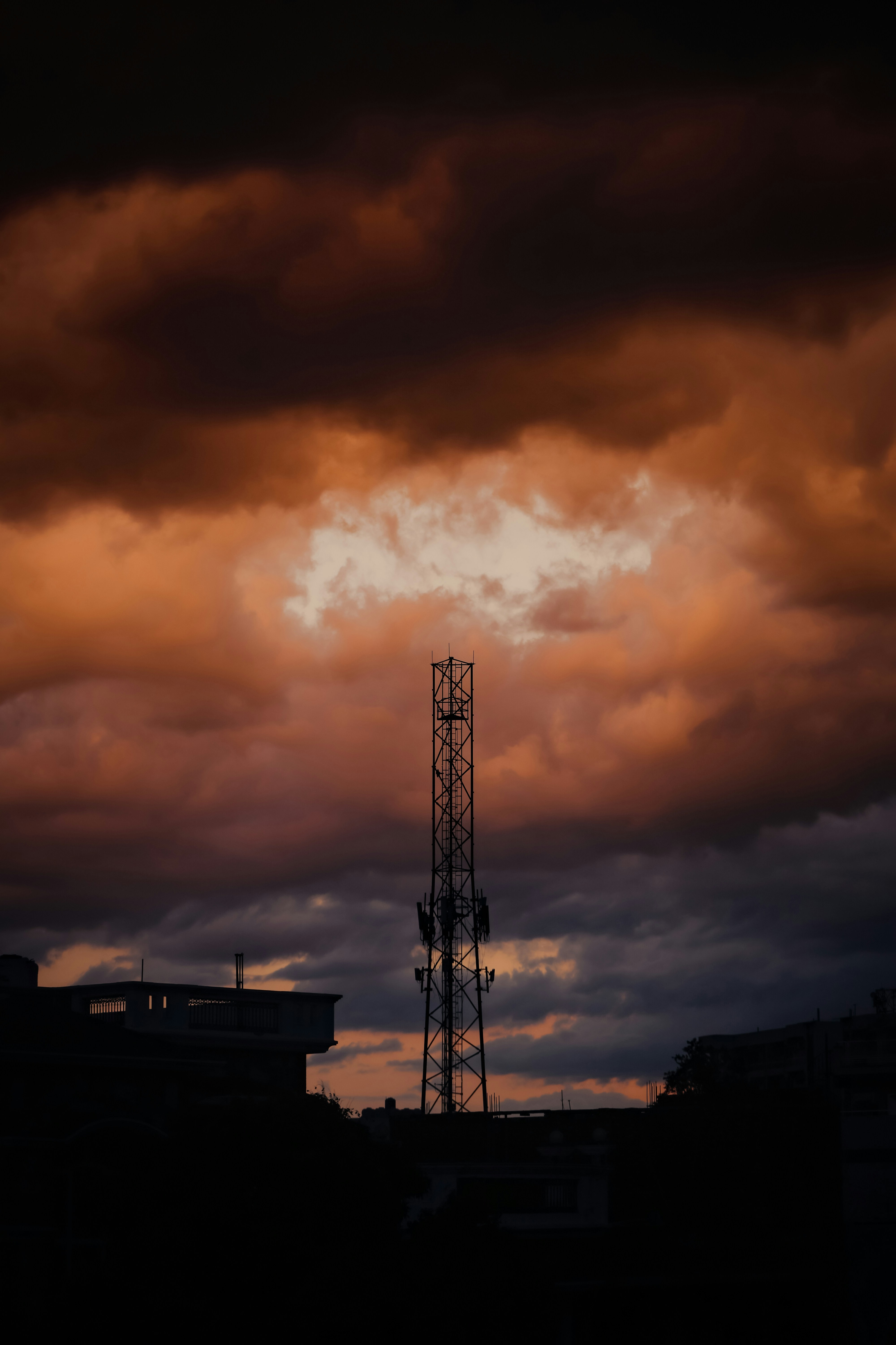 Tower Silhouette Above a Horizon of Fiery Clouds at Dusk