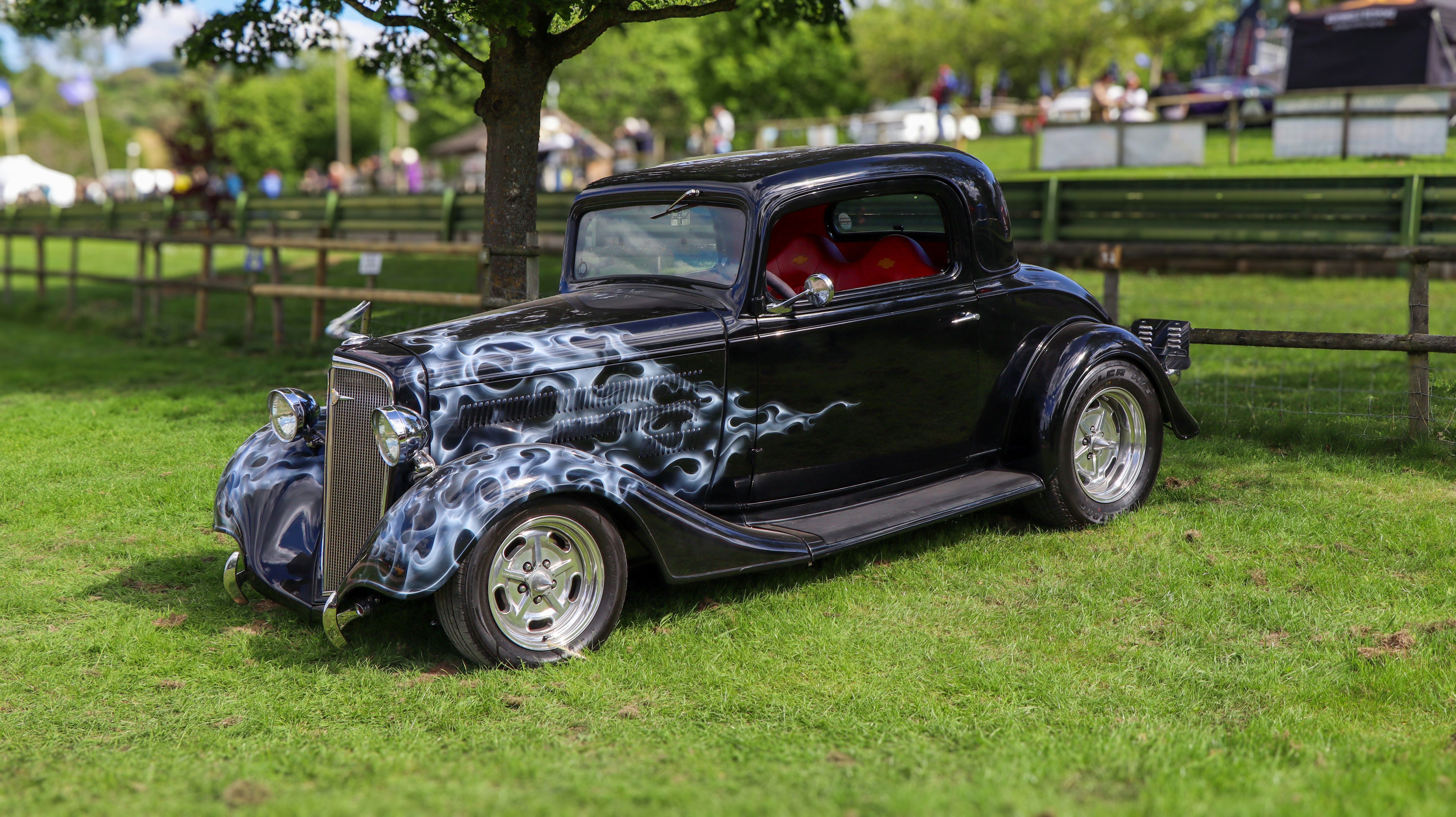Flame-inked Classic: a custom hot-rod gleams on the meadow