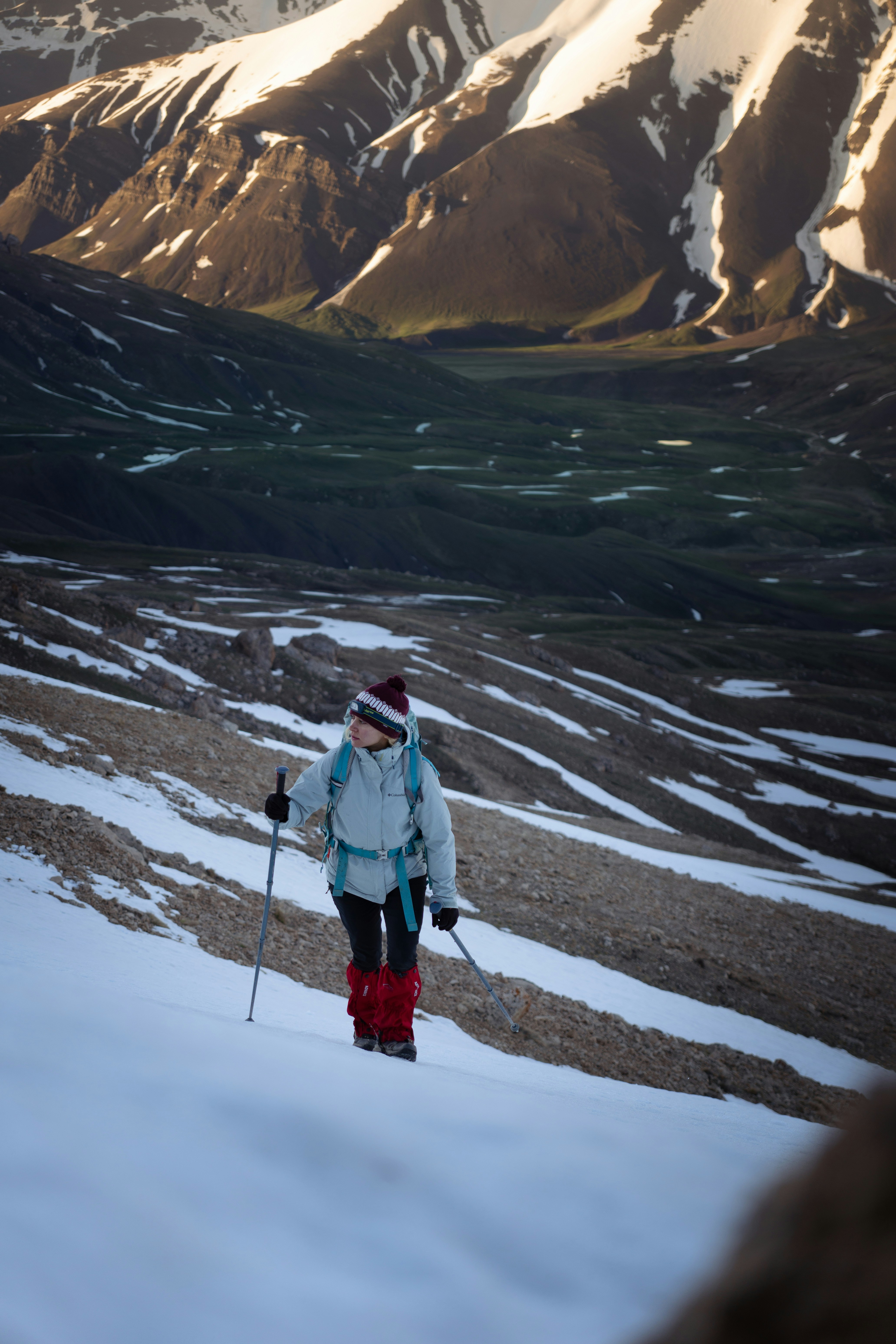Snowbound Ascent: A lone climber threads a ridge under jagged, snow-dusted peaks