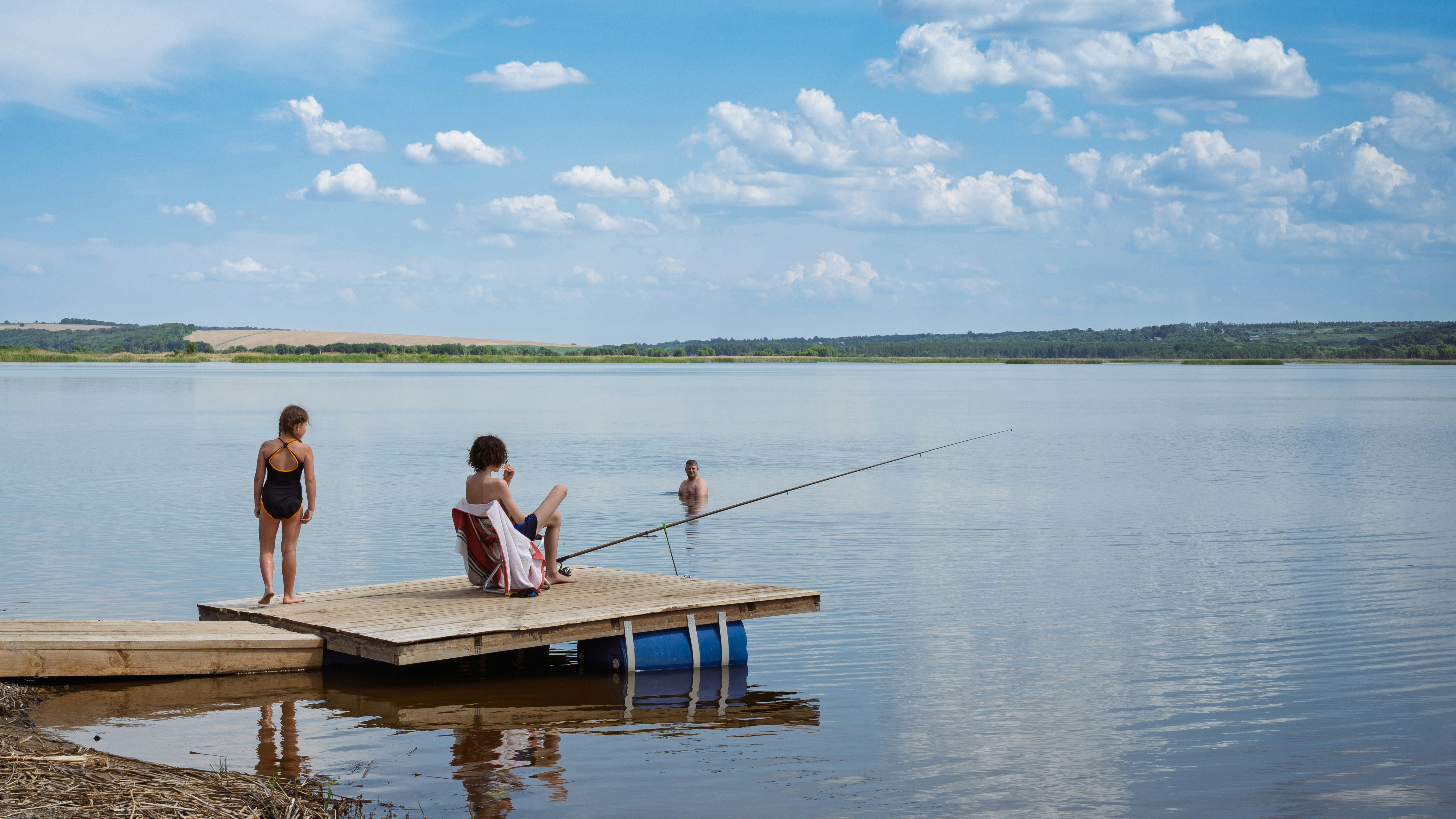 Quiet Fishing Trio at a Sunlit Lake