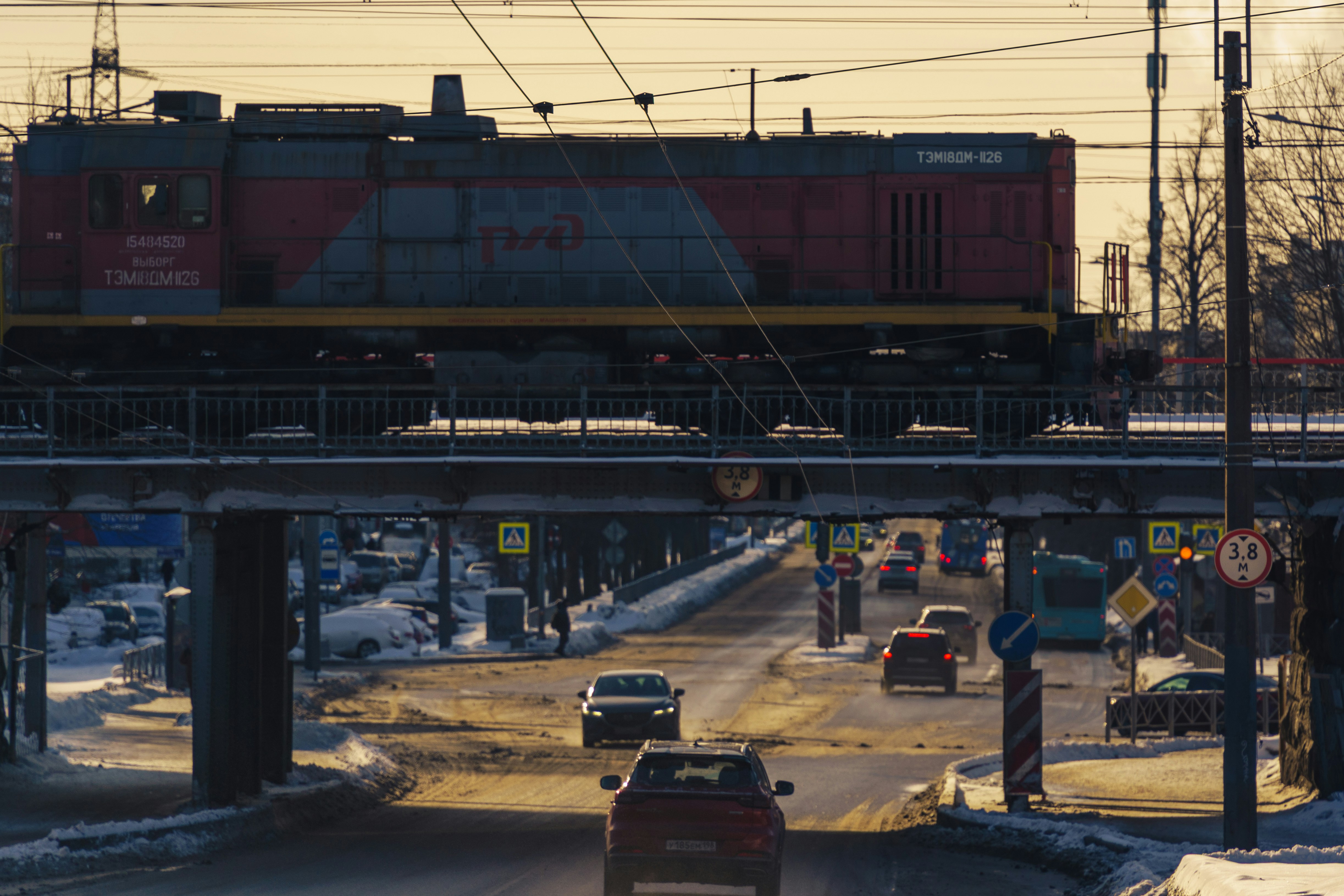 Railway Guardian: A Freight Train Rumbles Over a Snow-Swept City Street