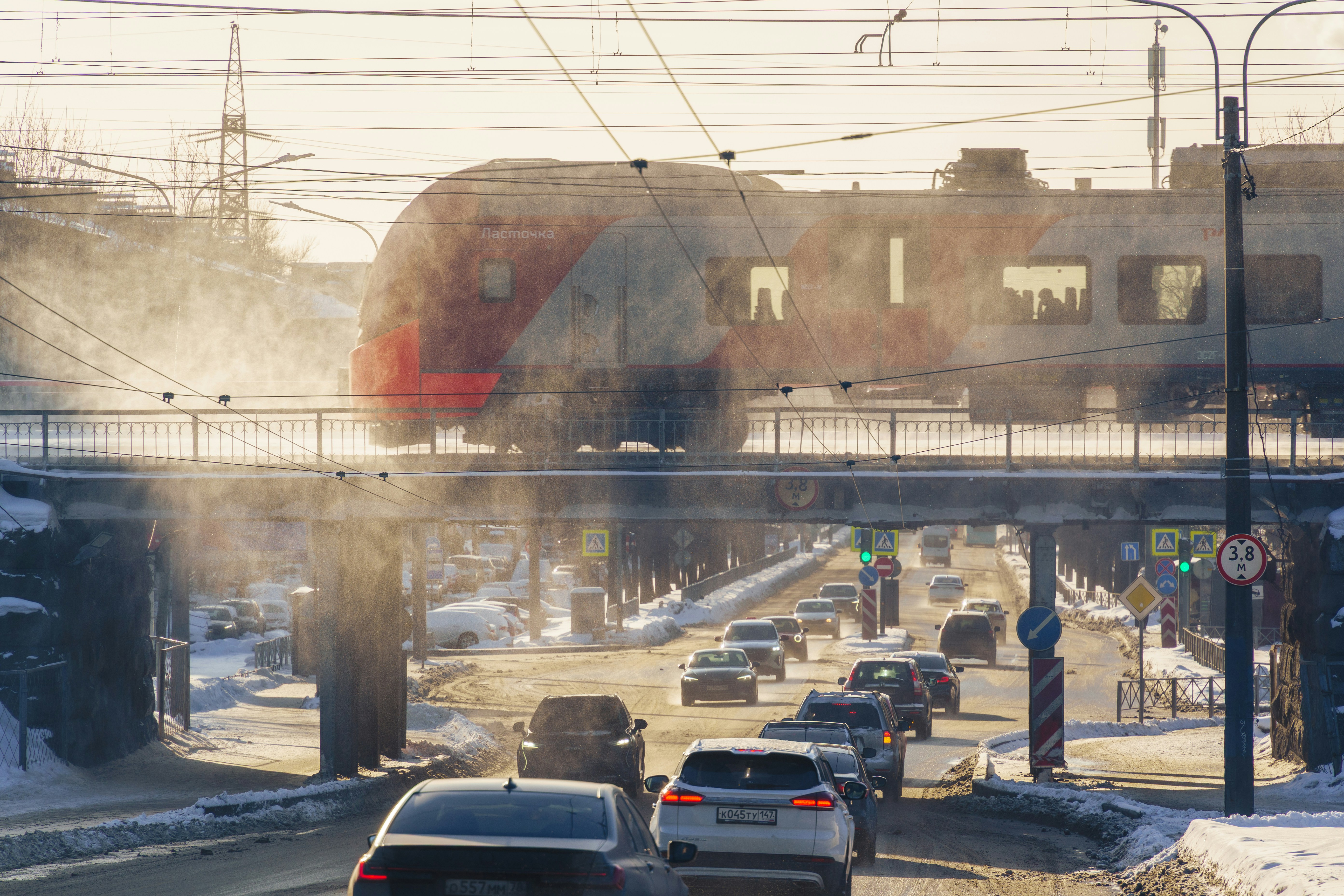 Sunlit Commuter Street Beneath a Rolling Train