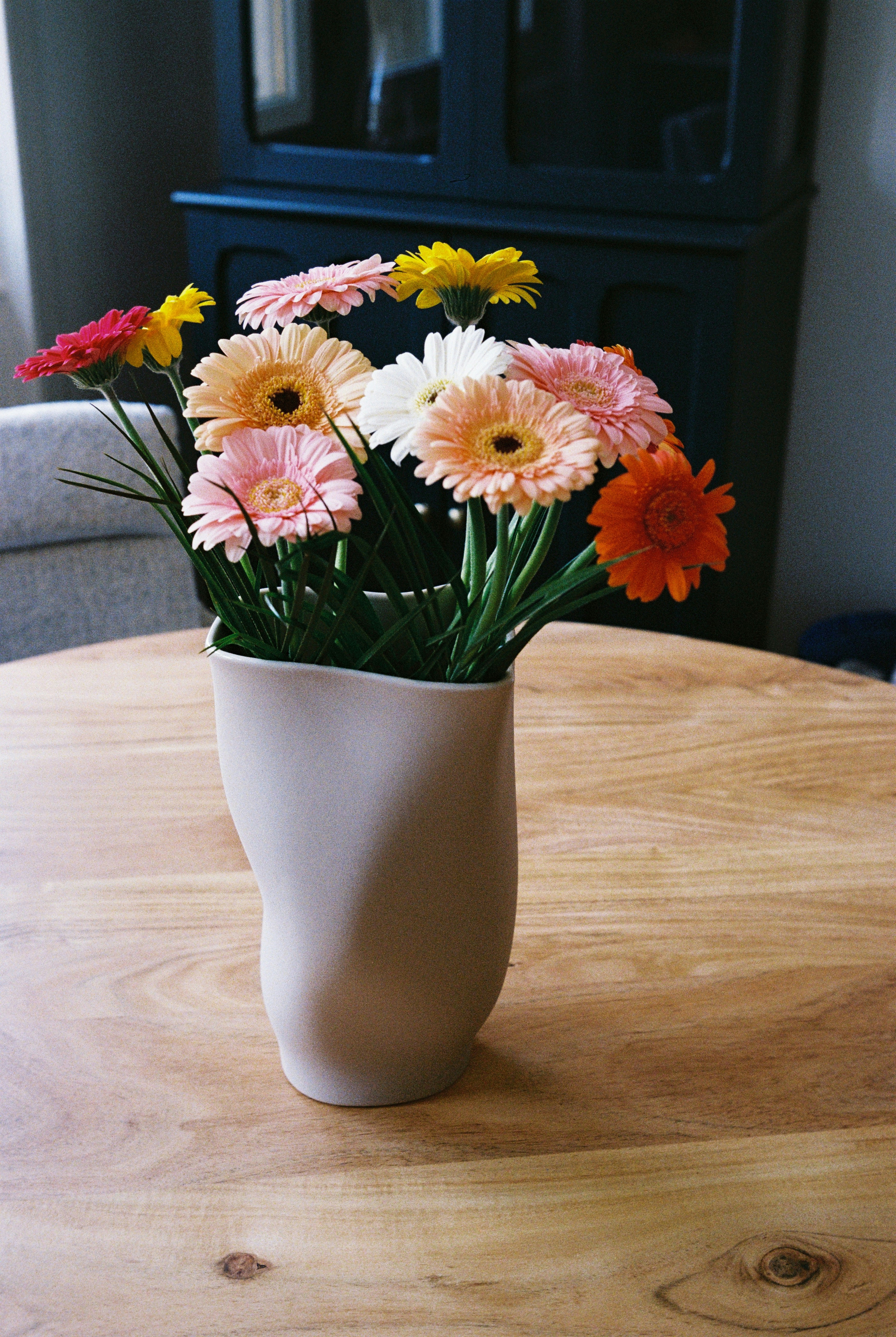 Pastel Gerbera Bouquet in a Minimalist Vase on a Wooden Table