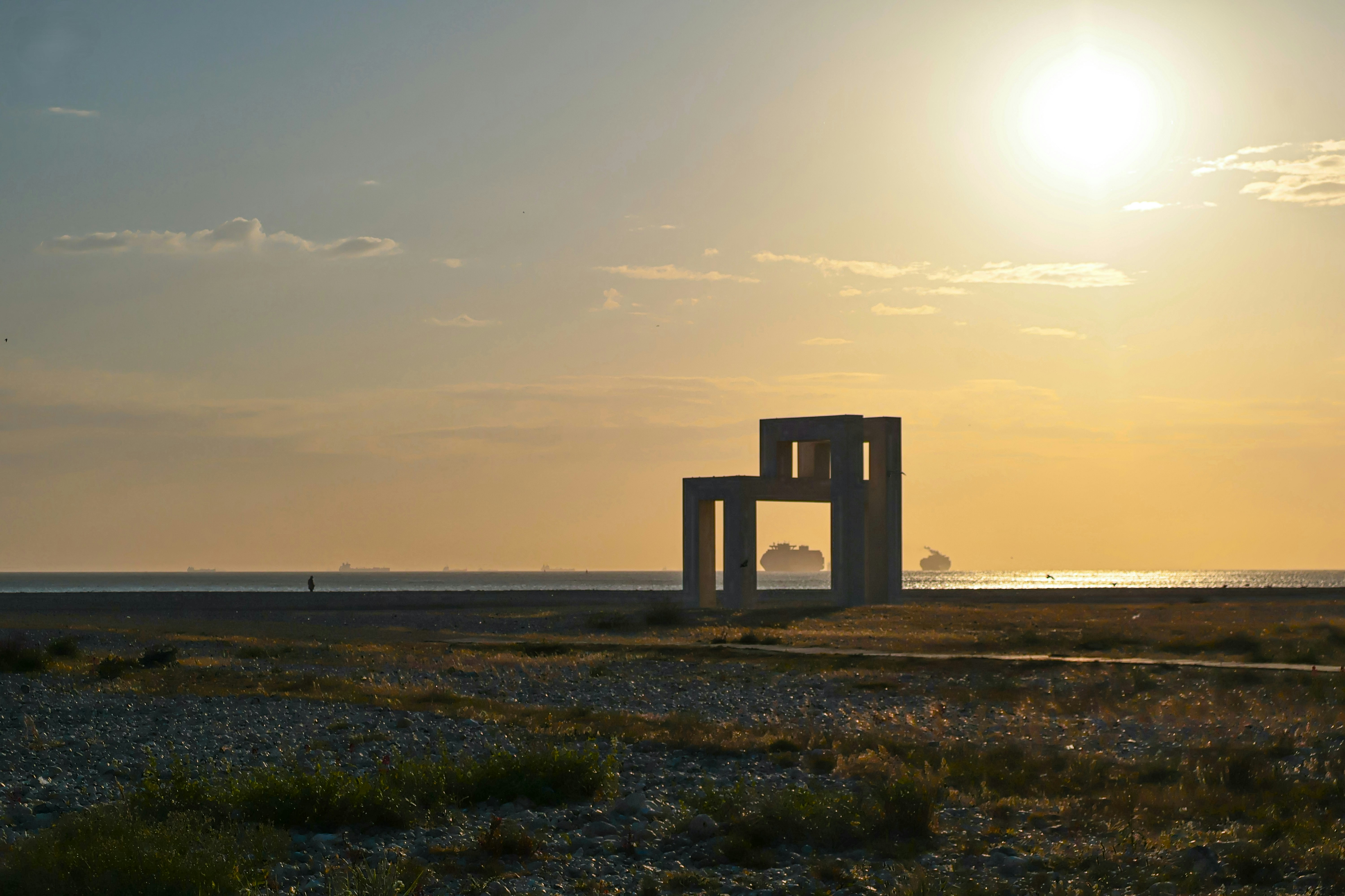 Sunset over the Seawork Arches: Monument Framed by Dunes