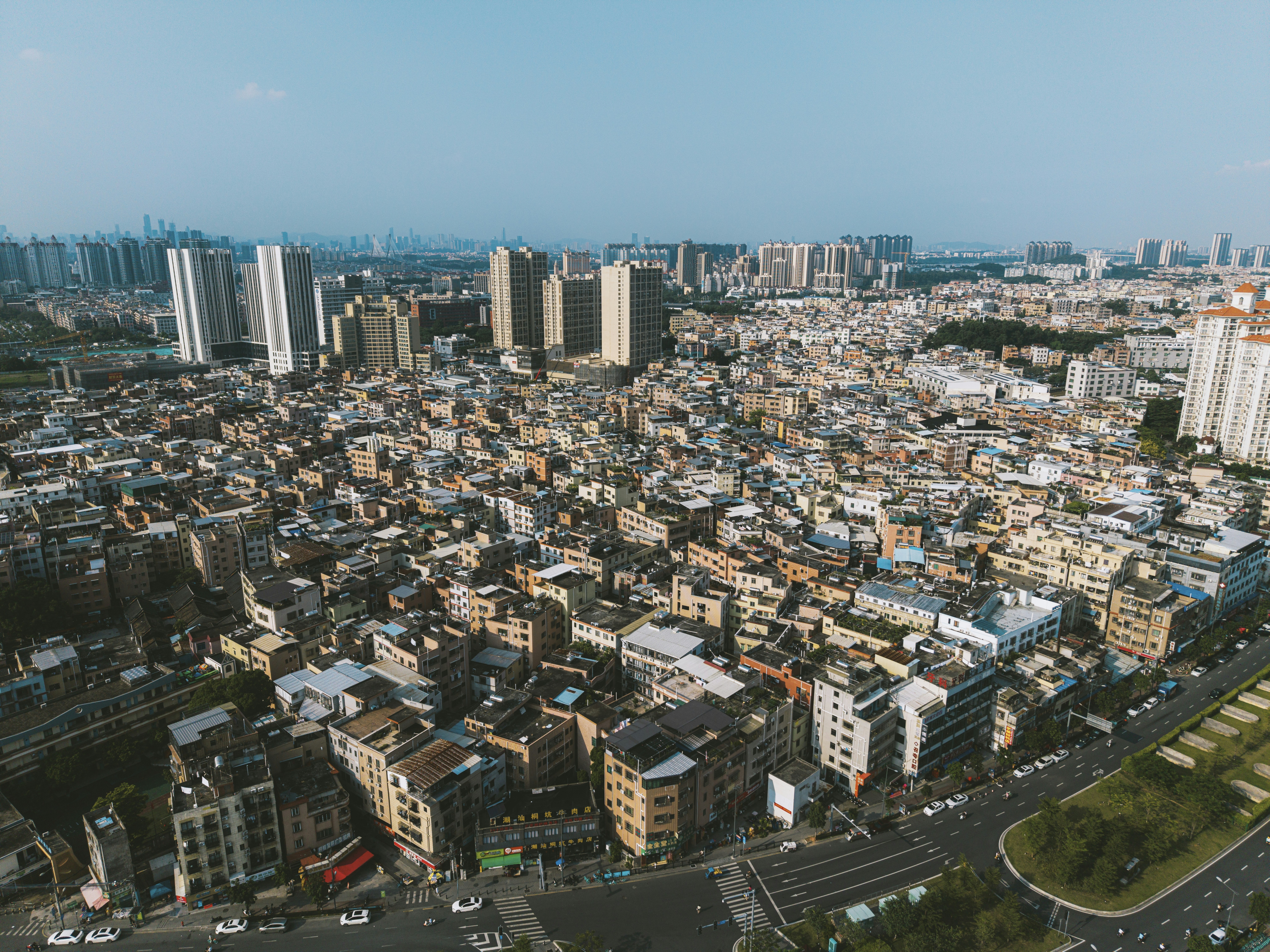 Urban Mosaic: A Sea of Rooftops and Distant High-Rrises