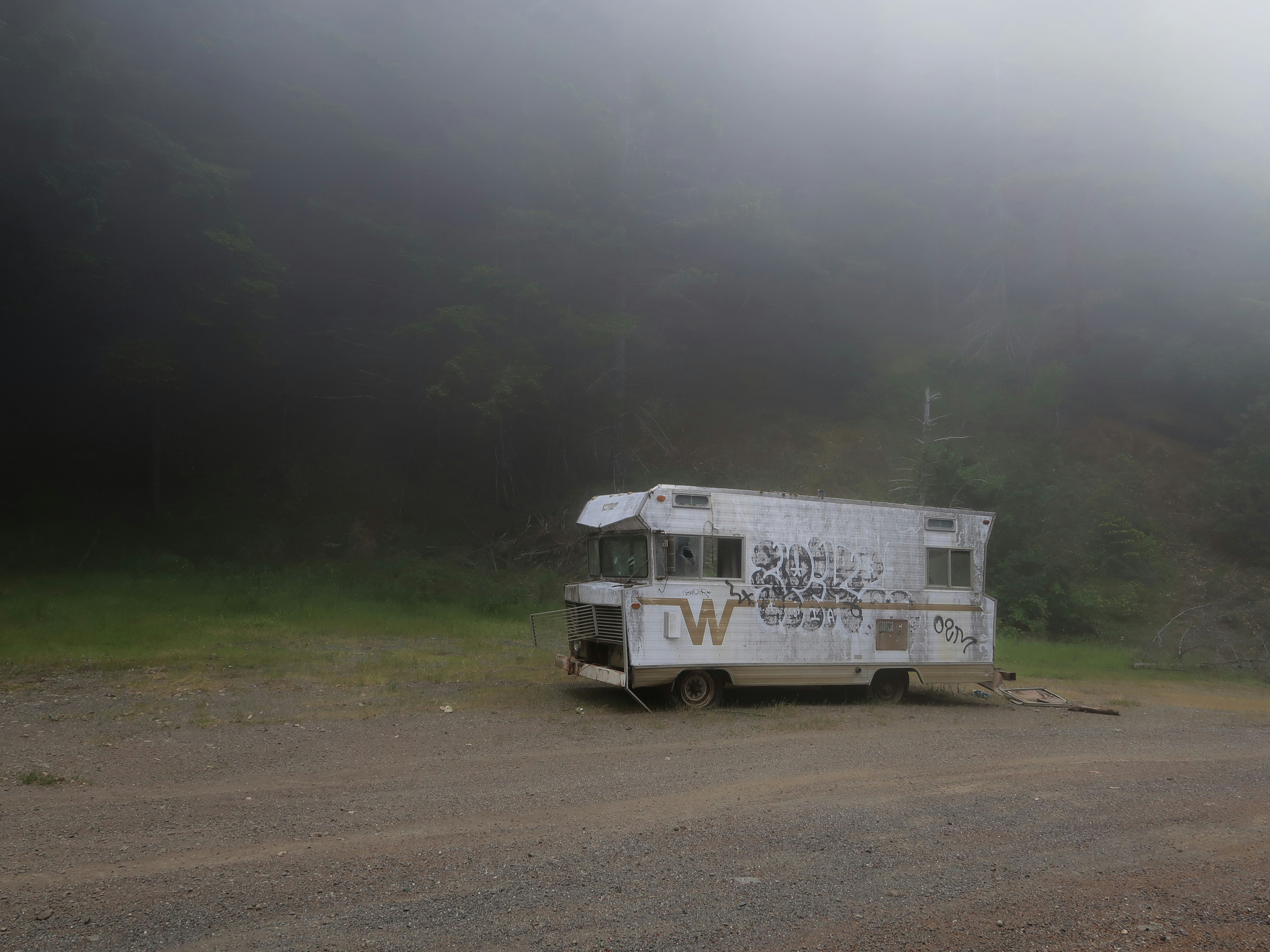 Stalled Wheelhouse in Mist: An Aging Food Truck Waits on a Fogged Clearing