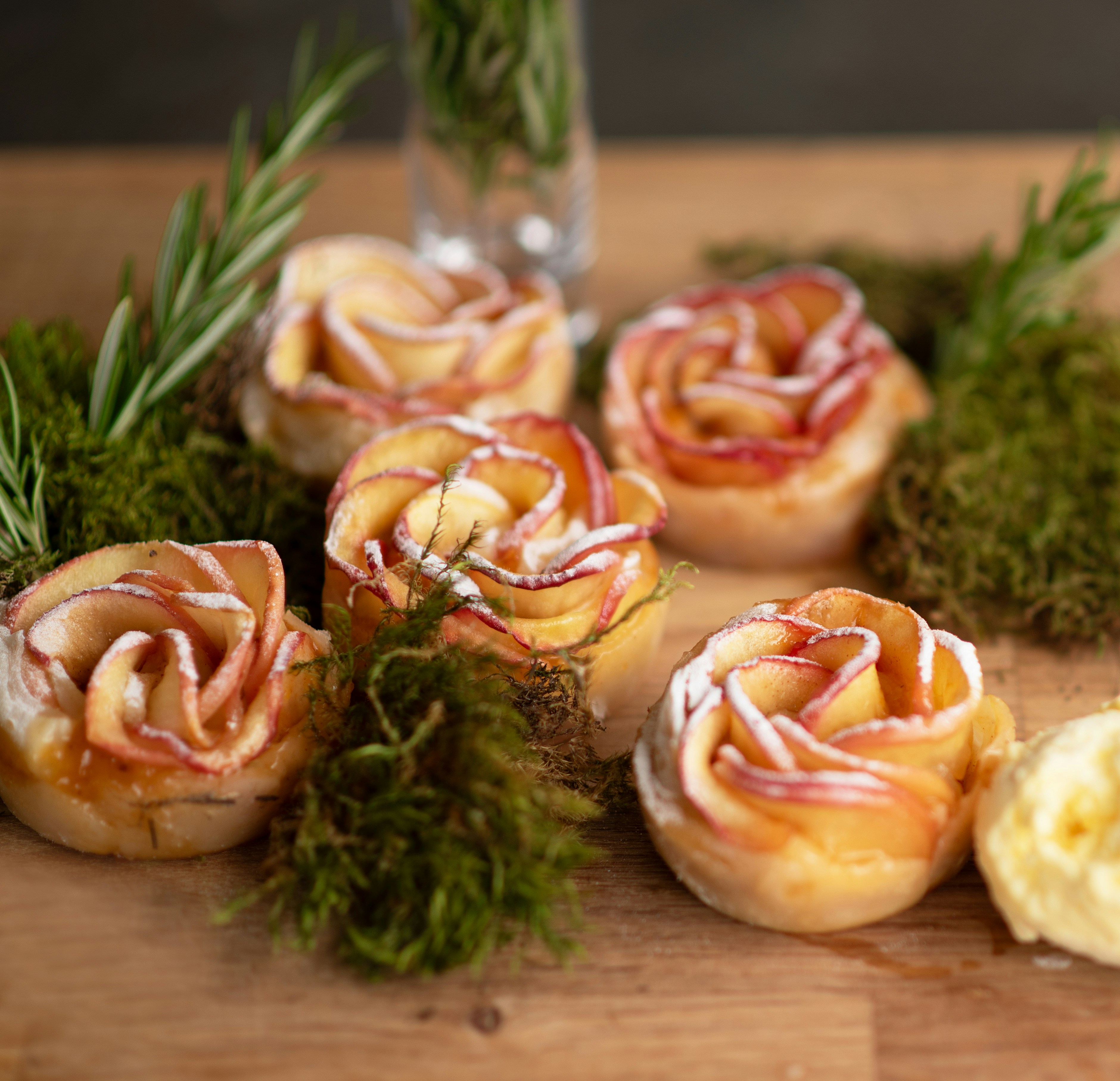 Petite Rosette Pastries Framed by Moss and Greens
