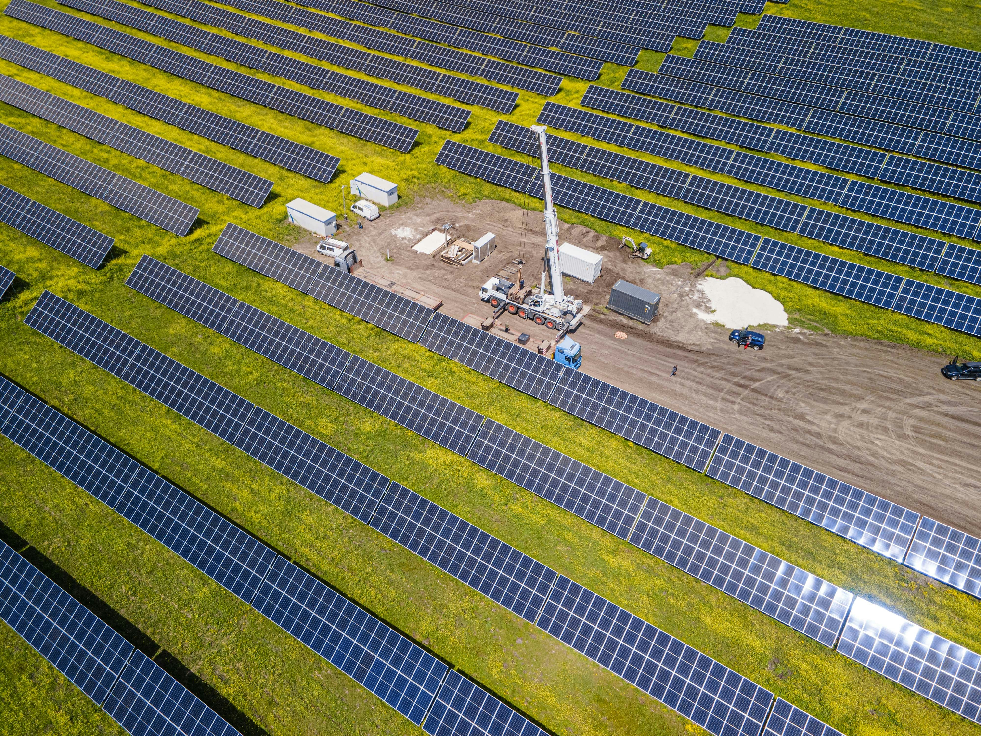 Aerial Grid: Solar Panels Align Across Green Fields