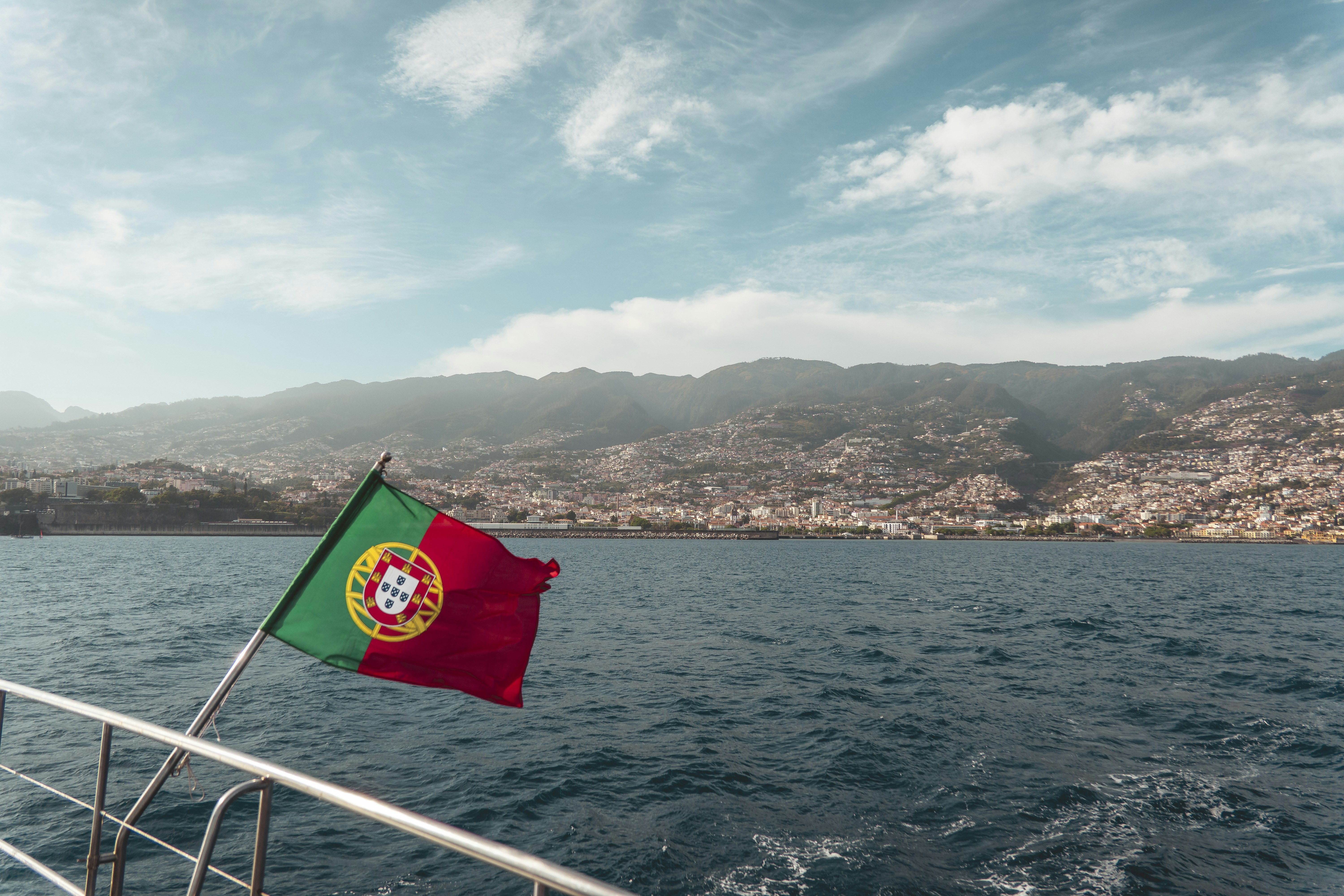 Flag Over Sea Valleys: A Portugal Coastline from a Boat