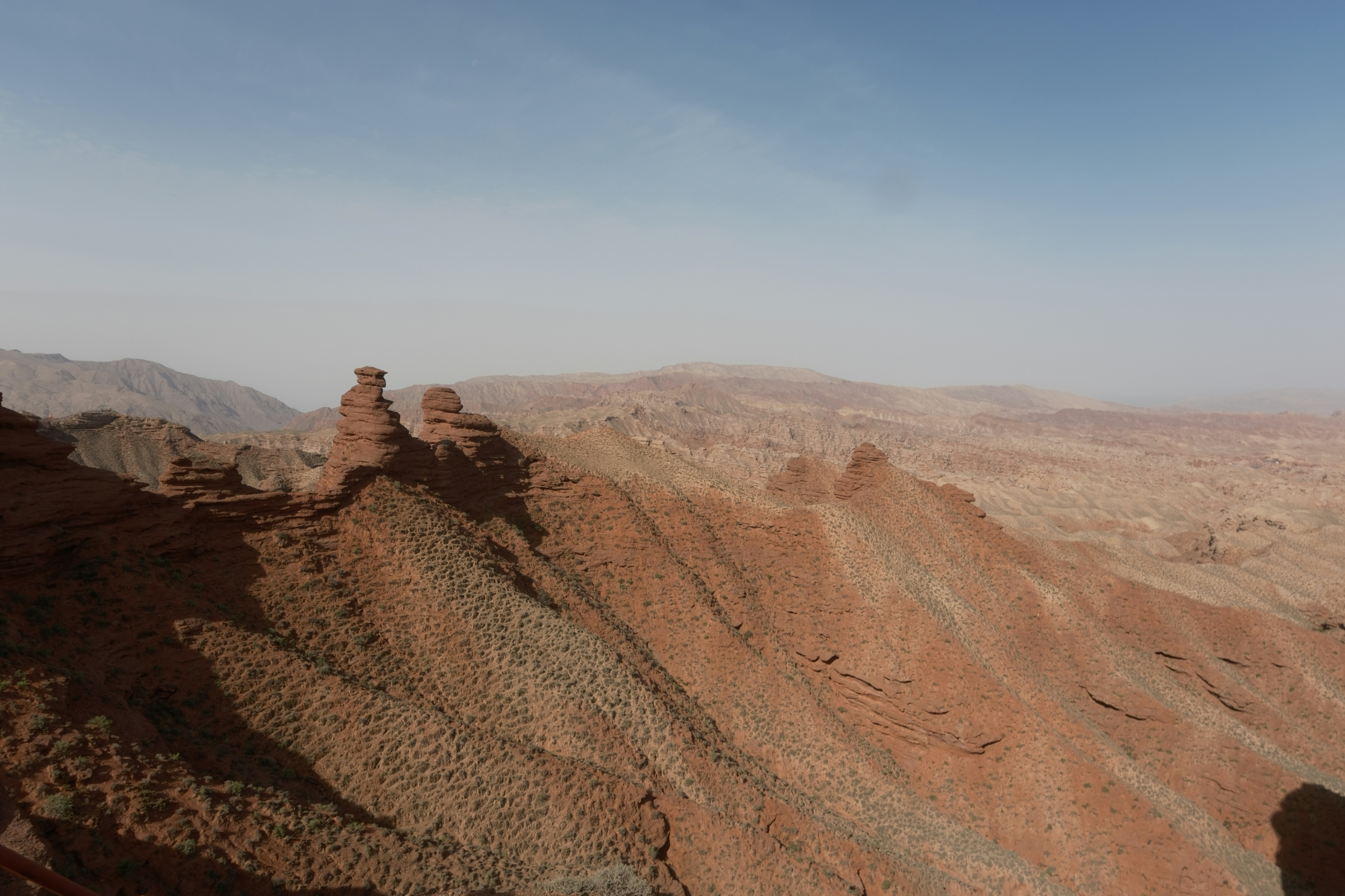 Desert Ridge at Dusk: Weathered Formations Against a Pale Horizon