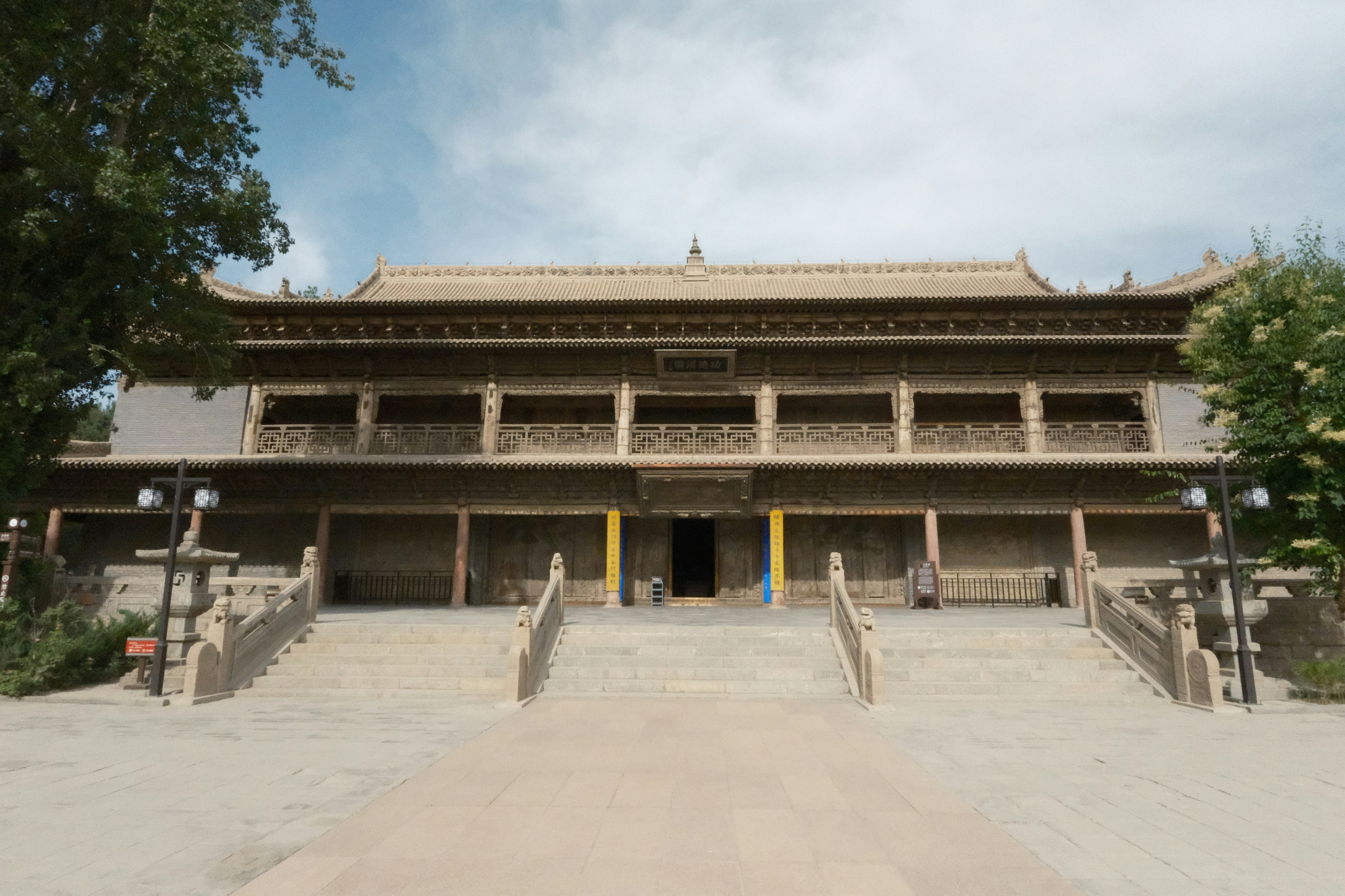 Historic building with a wide staircase and traditional architecture.