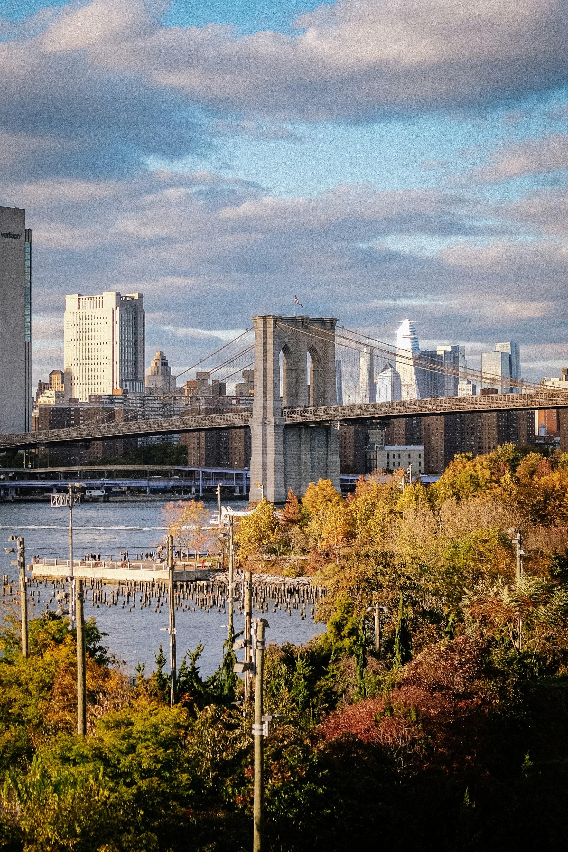 Bridge and Skyline over a Colorful Riverside Park
