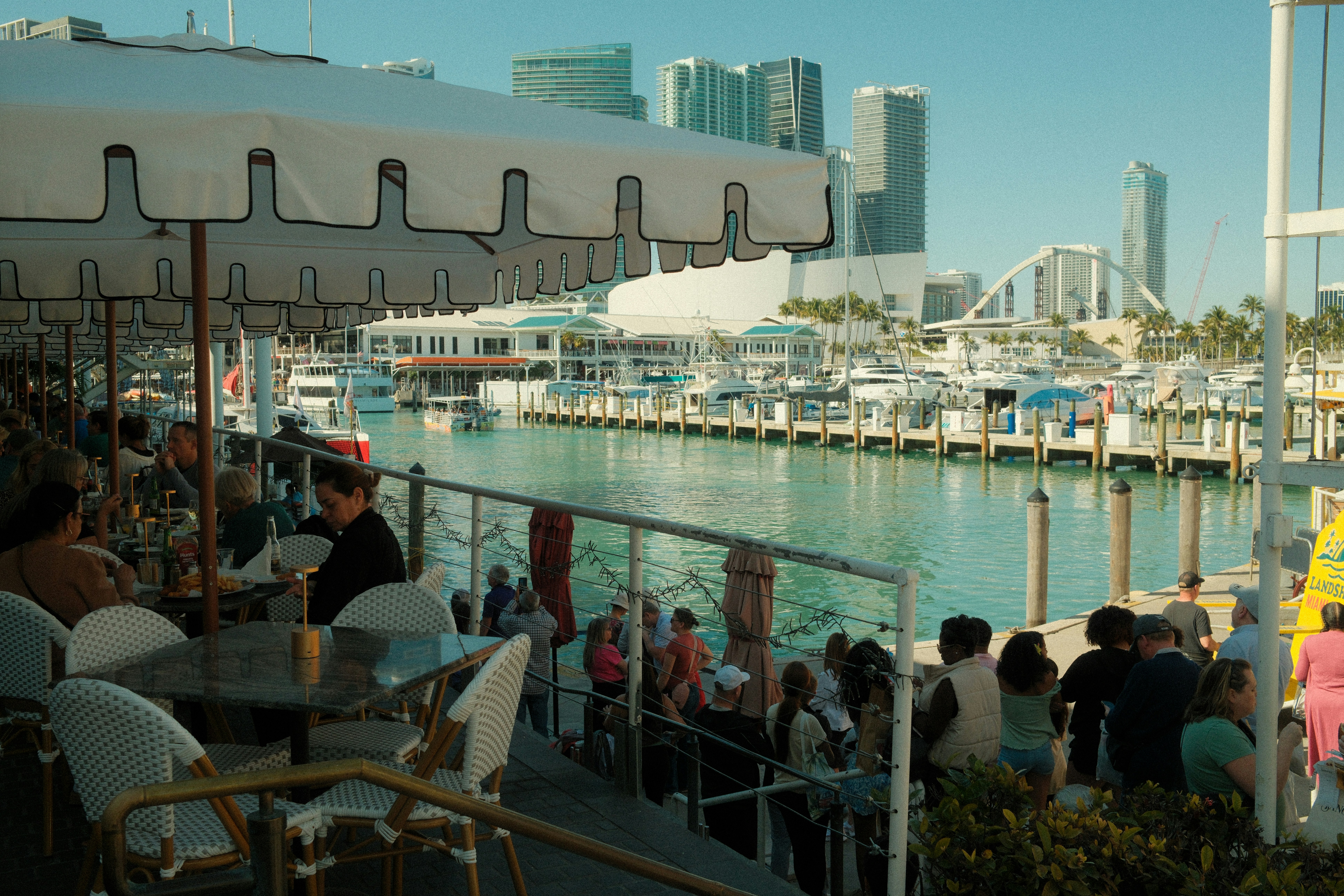 Dockside Lounge under the Canopy: Sunlit Seascape with Busy Terrace