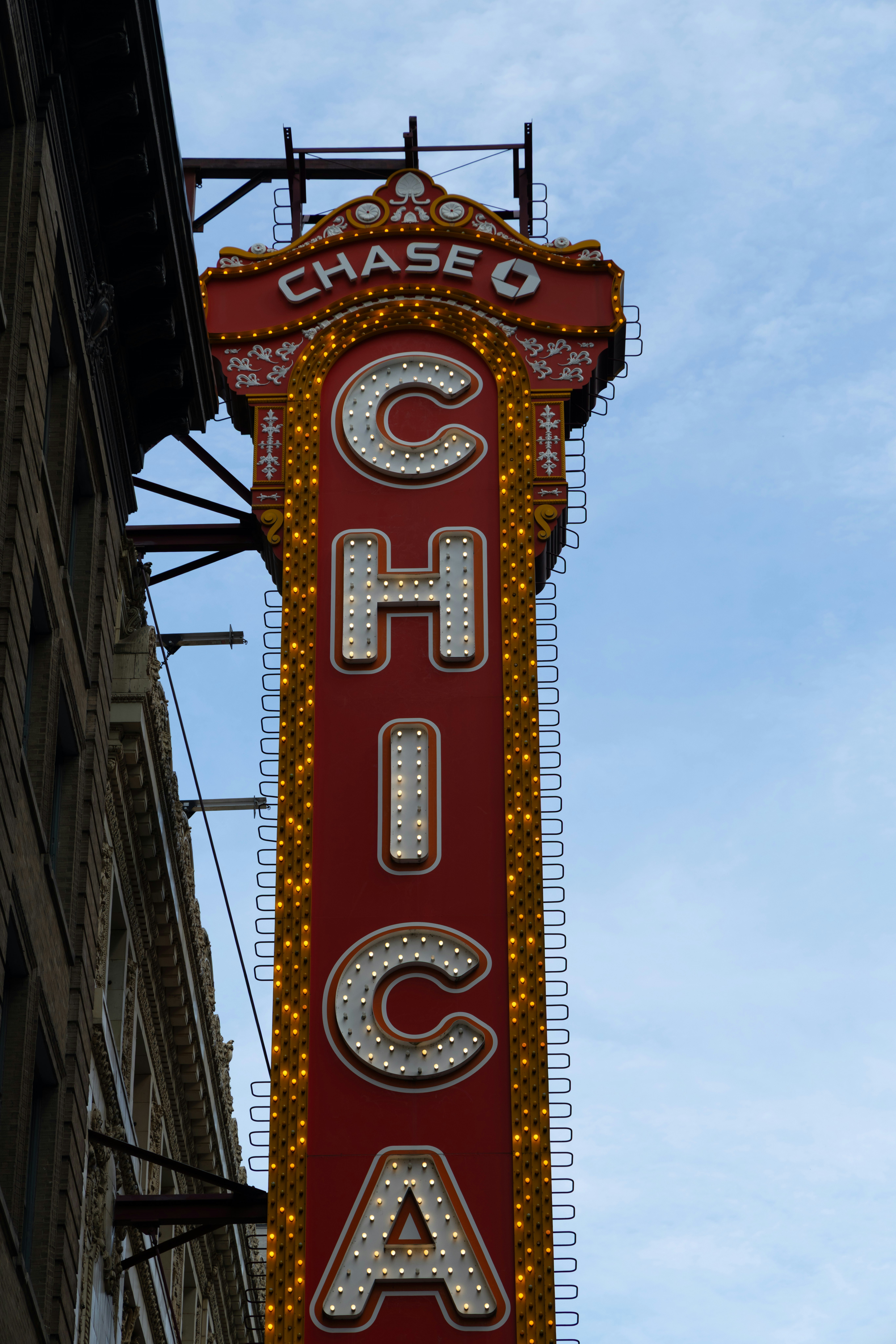 Vertical red chiliad: the Chase sign rising above a city street