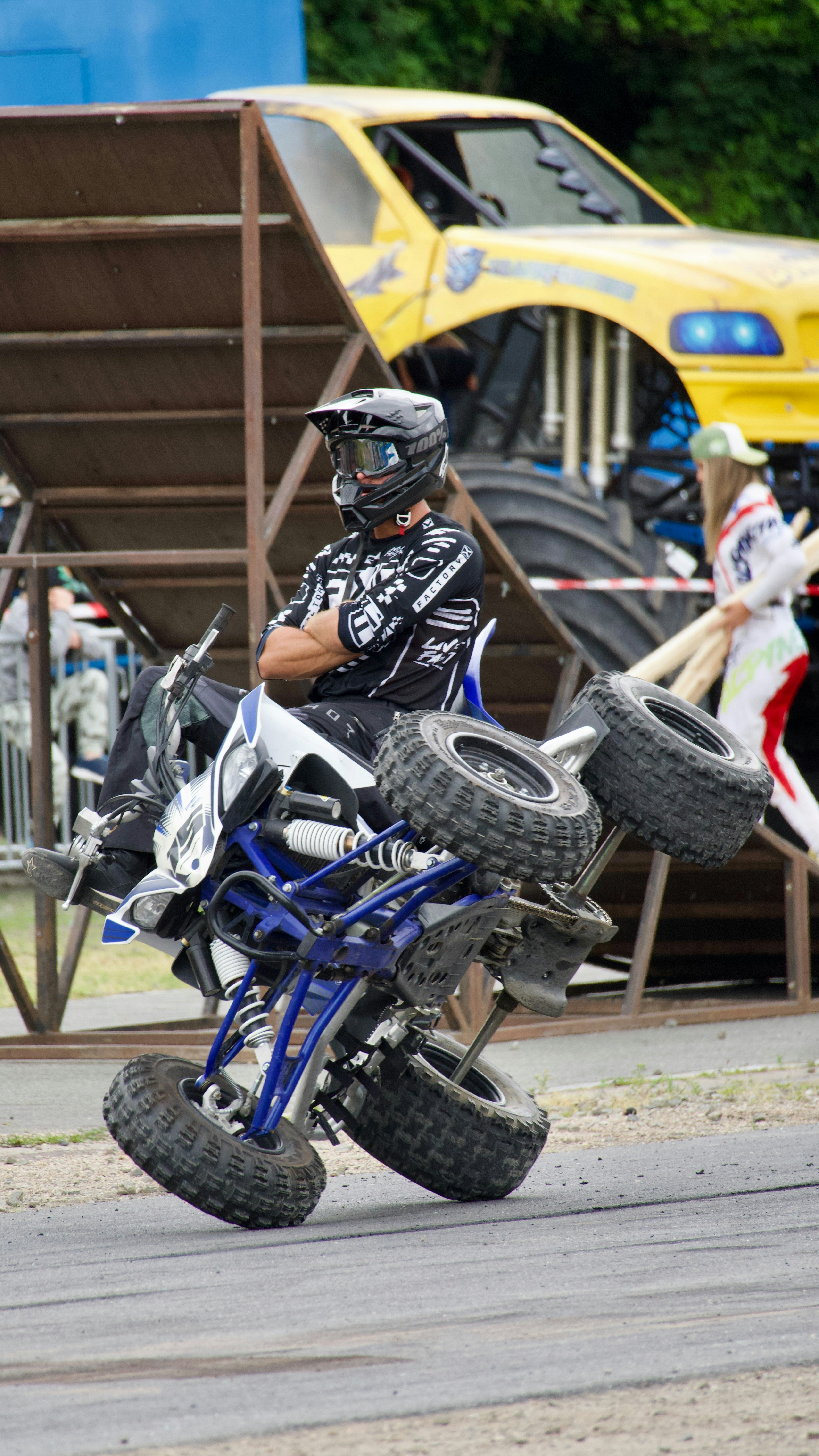 Midair Pivot: Rider in the Moment of a Wheelie on the Dirt