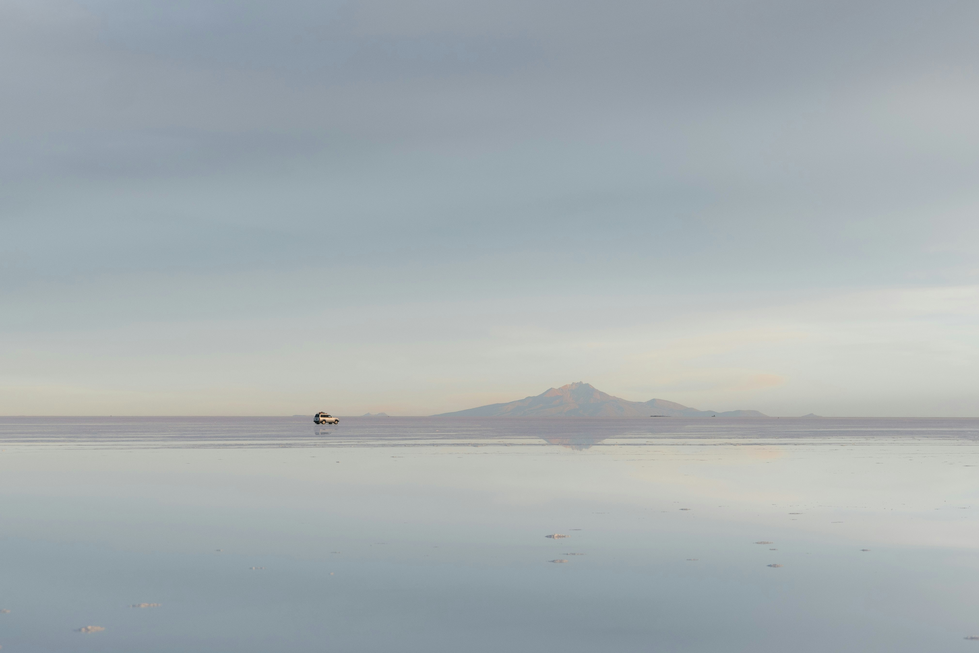 Silent Horizon: A Lonely Boat Above an Expansive Salt Flat