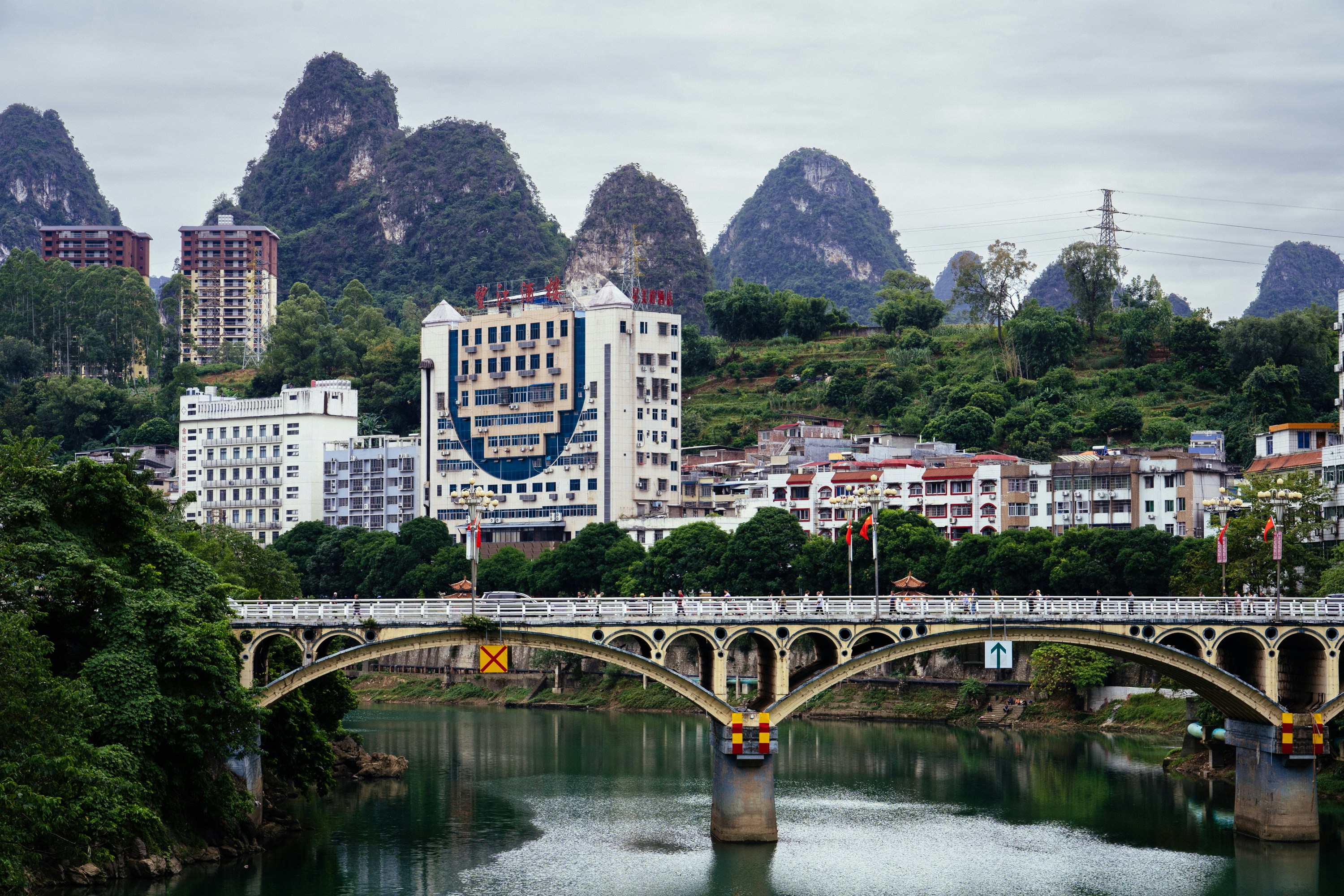 Urbanscape over the Li River: a city-stone bridge under karst silhouettes