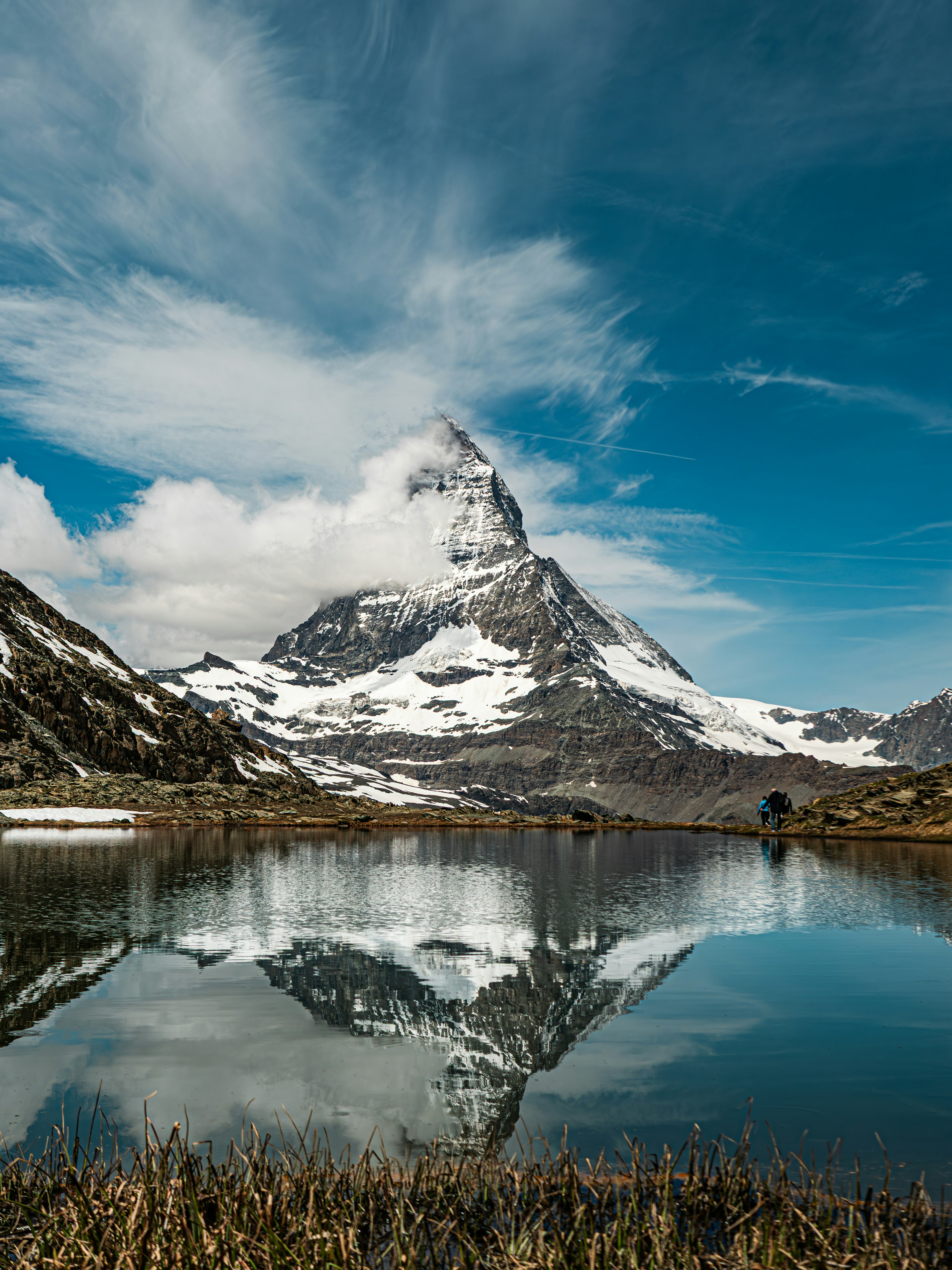 Majestic matterhorn mountain reflecting in a serene alpine lake.