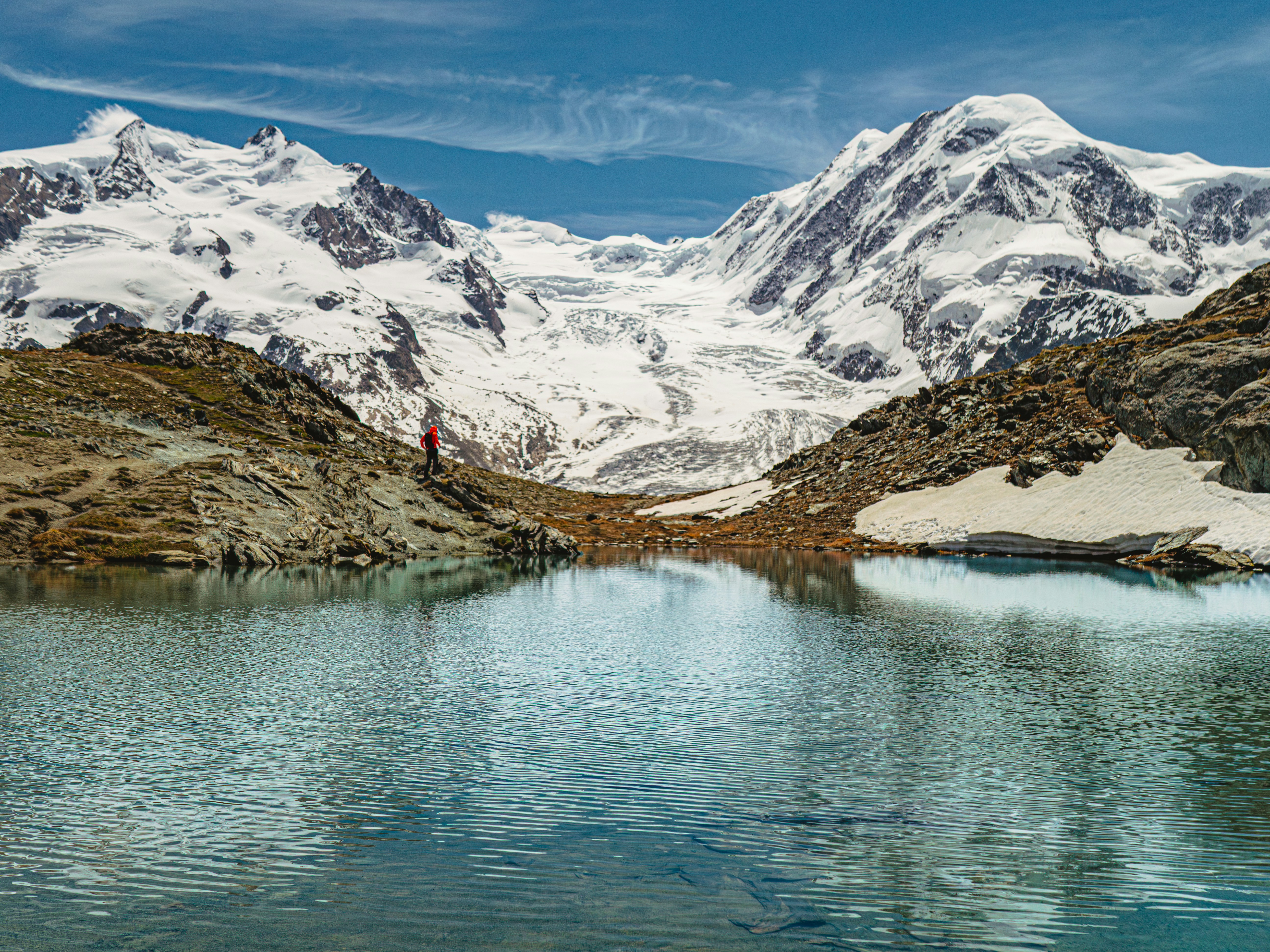 Glacial Mirror: Alpine Lac with Climbers Beneath Towering Peaks