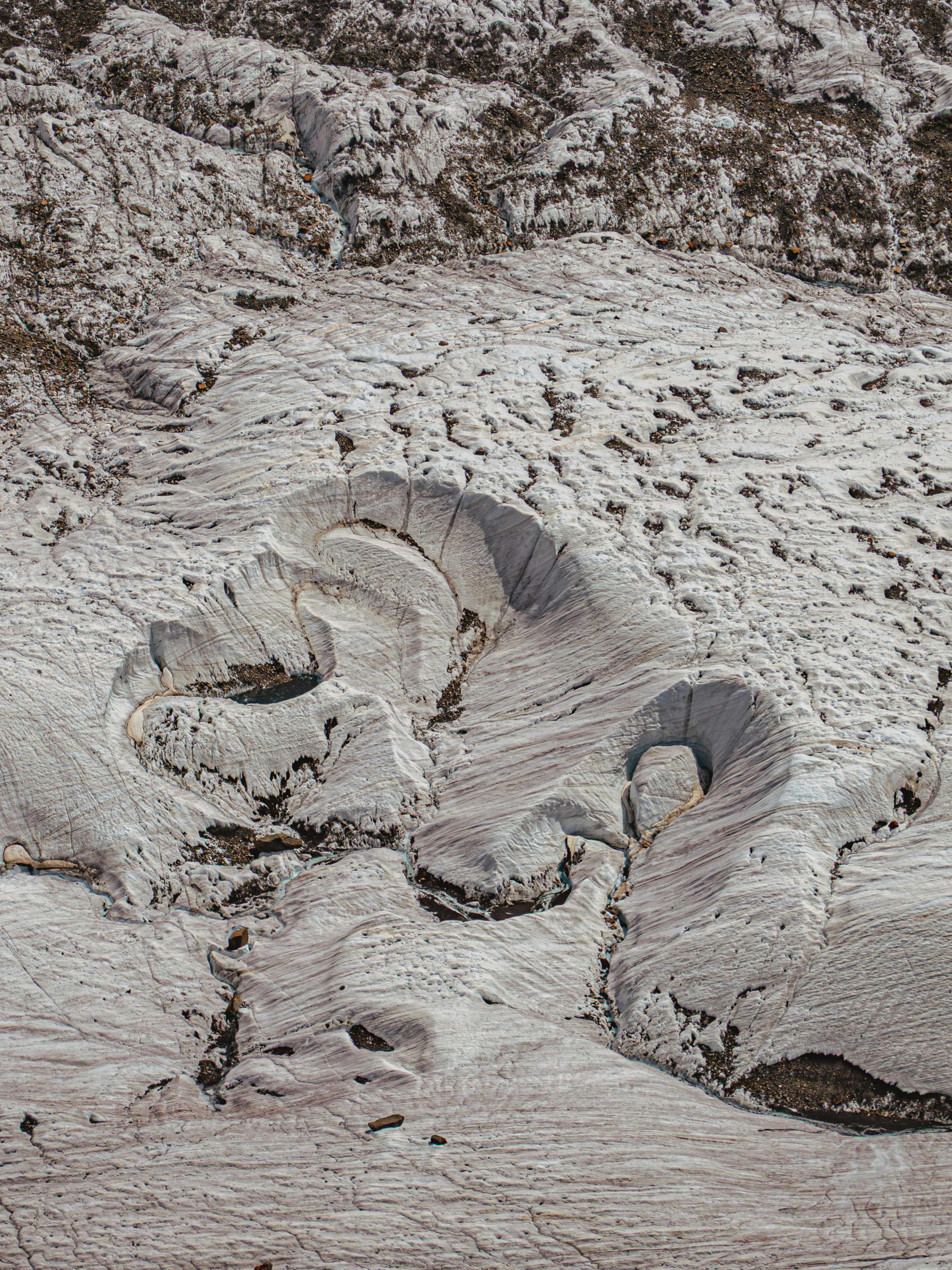 Eroded White Terraces: Wind-sculpted Circles on a Desert Plain
