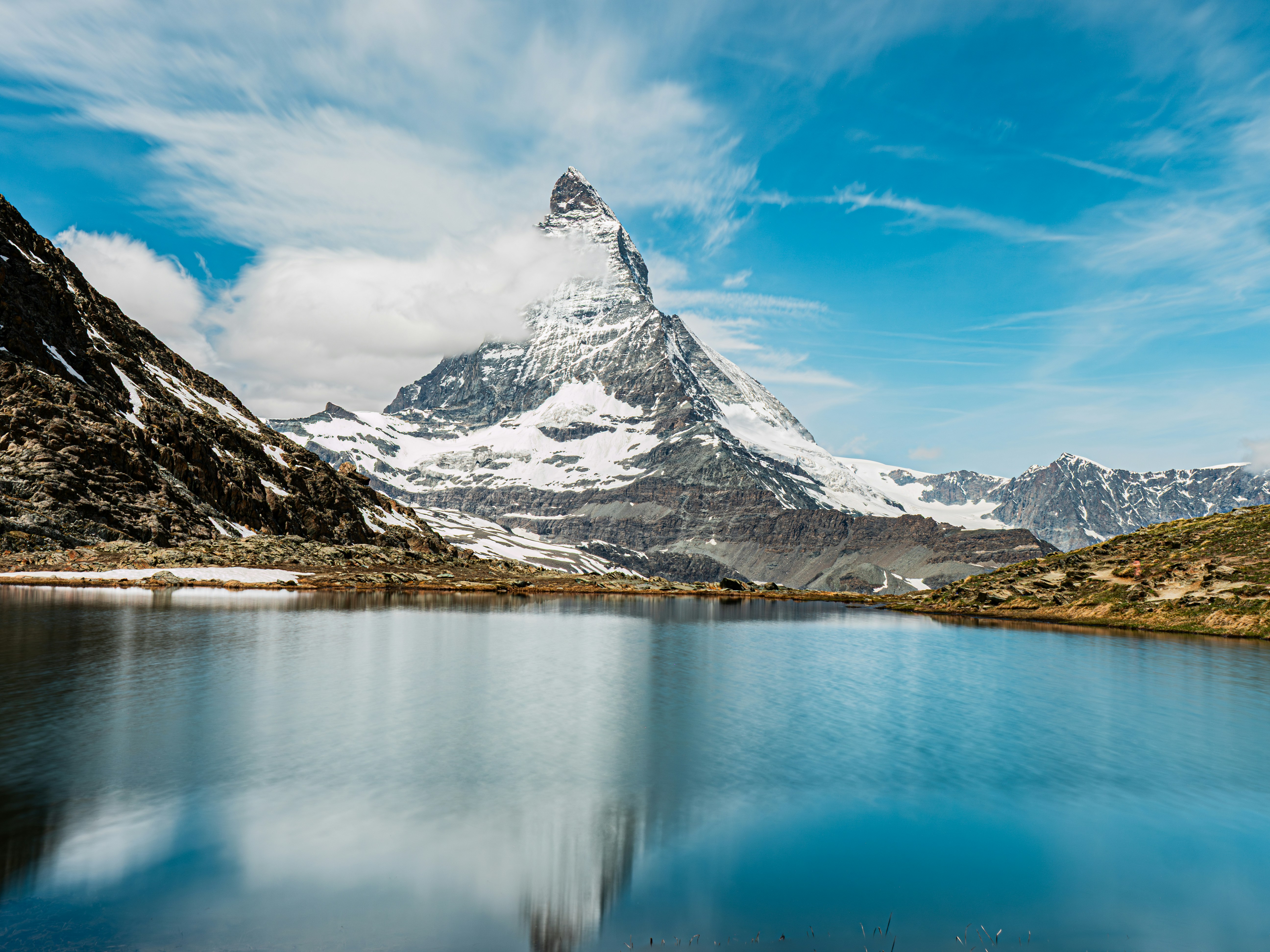 Majestic matterhorn mountain reflected in a clear alpine lake.