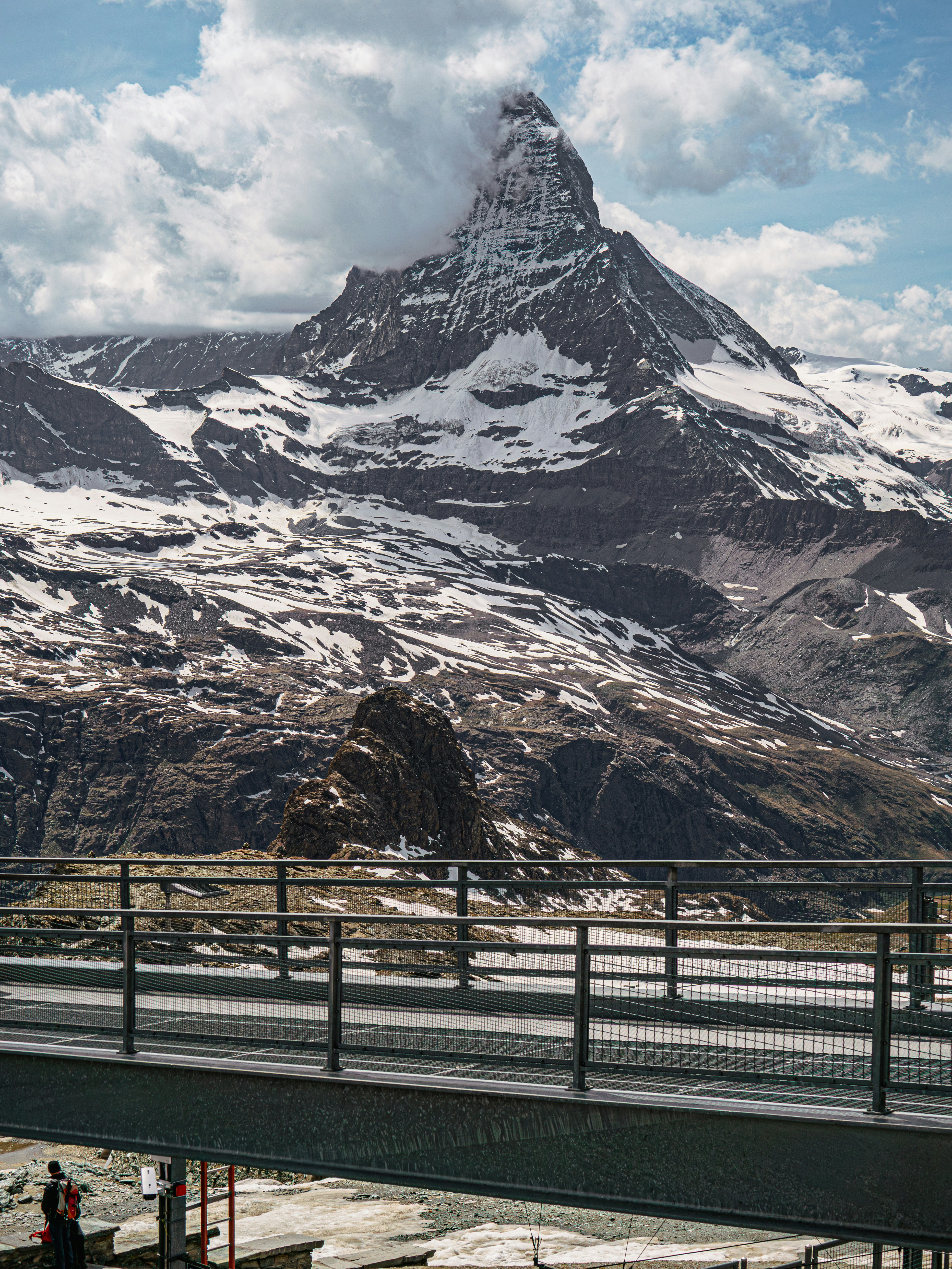 Matterhorn Shadowed by Snow: A Mountain Vantage from a Rail-Top Platform