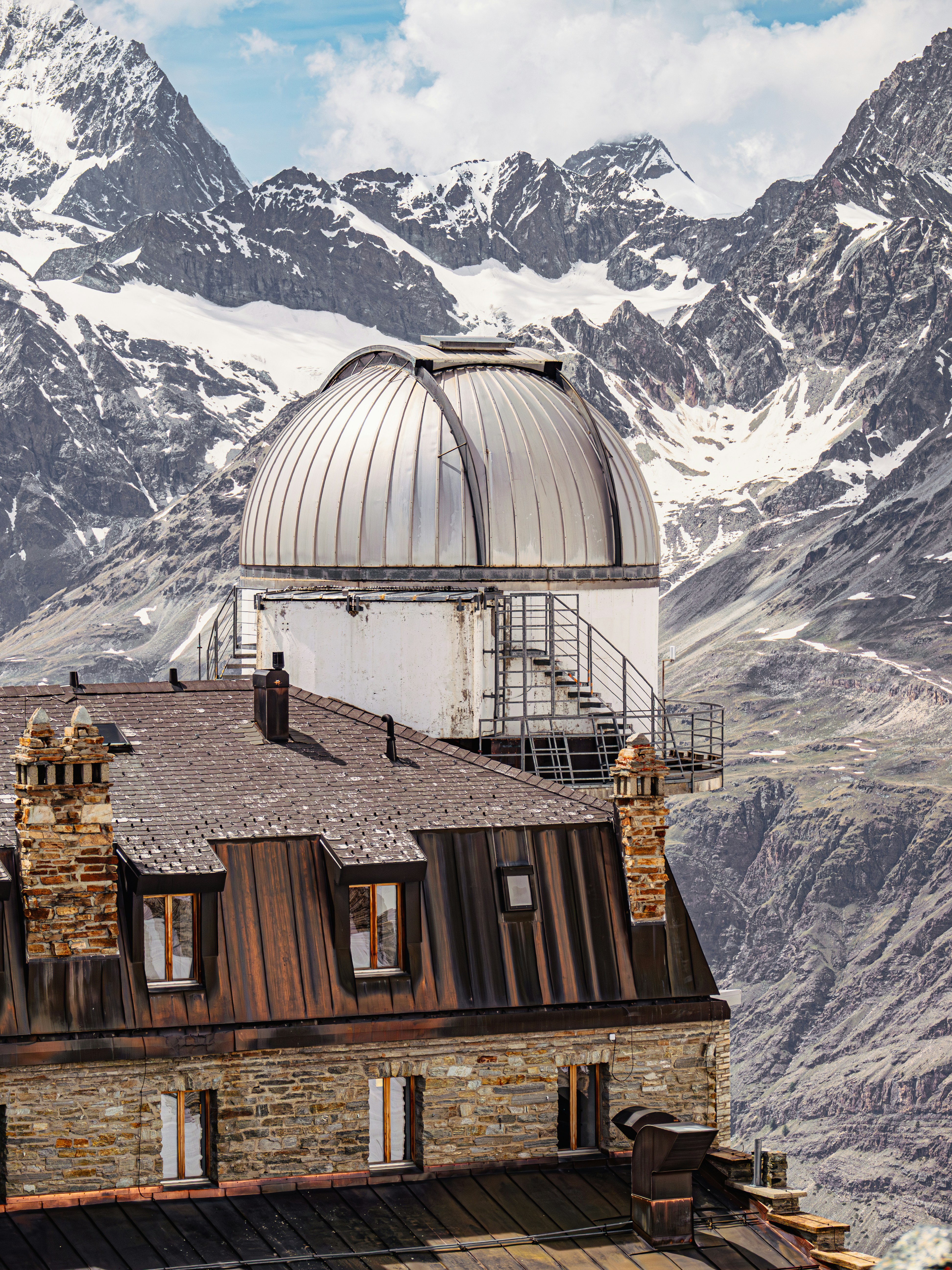 Observatory Dome Resting Above Alpine Roofs
