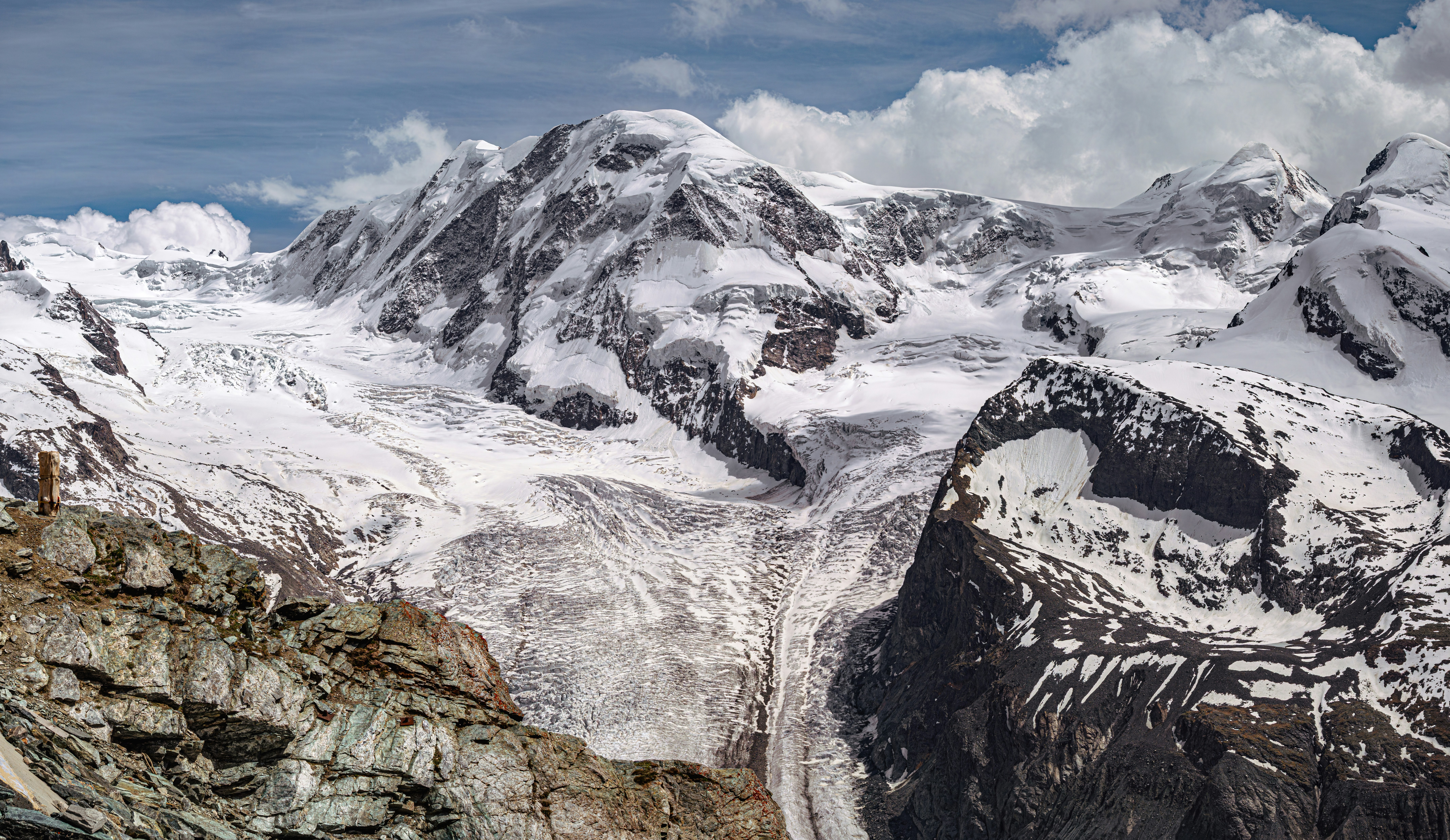 Glacial Prominence: Snow-Blanketed Peaks Beneath a Blue Sky
