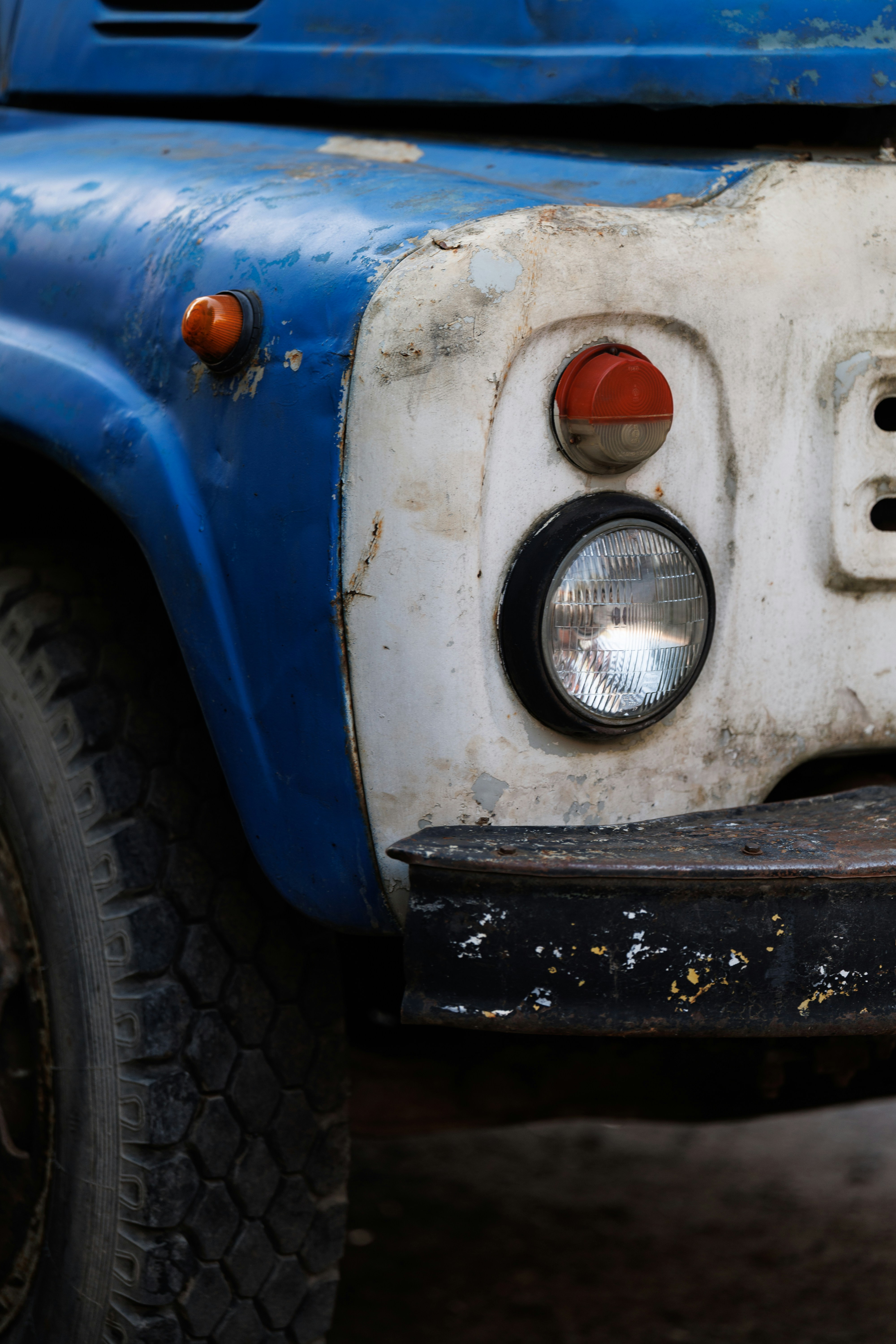 Weathered Blue Crusher: Close-up of a Dusty Front End