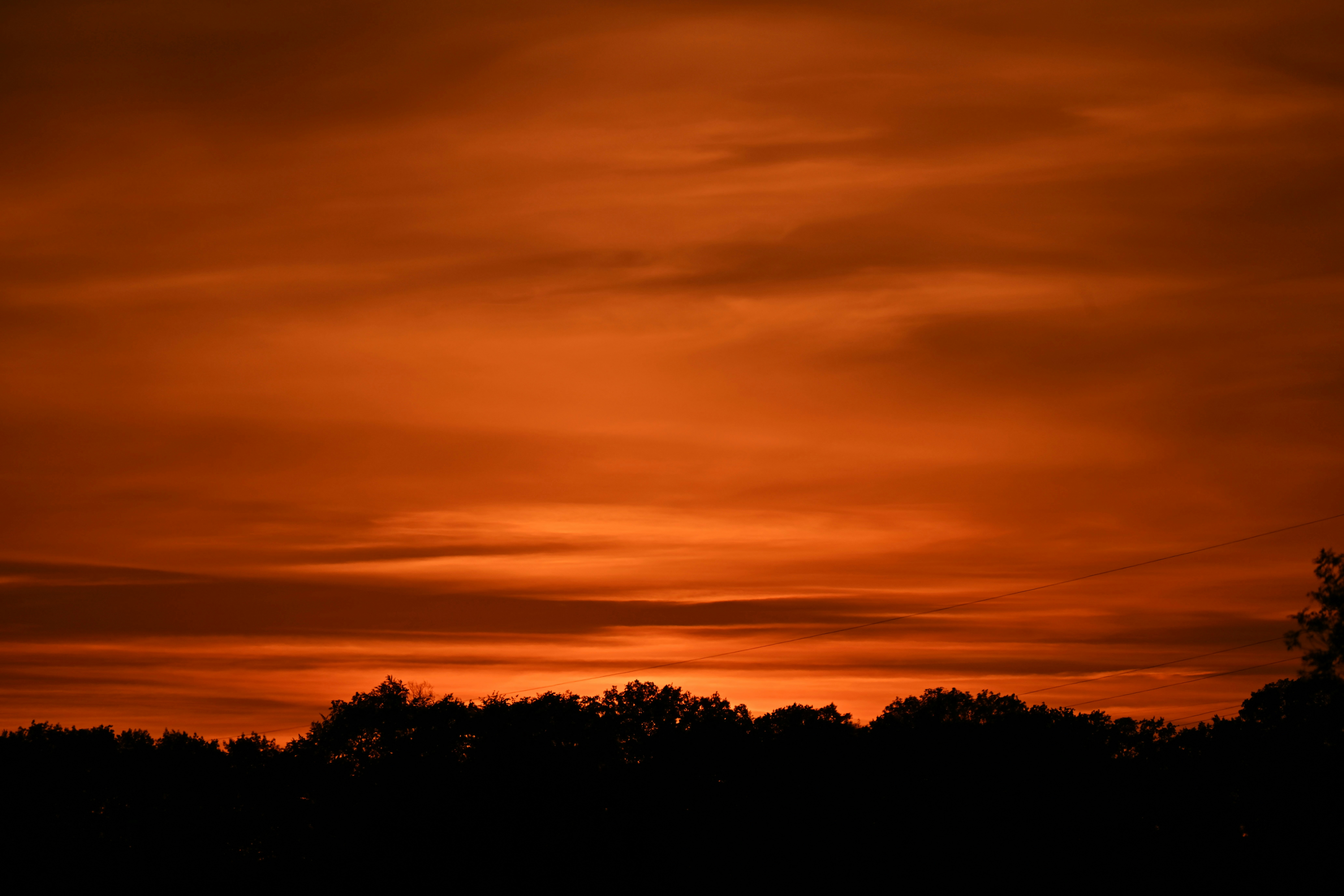 Blazing Horizon: Silhouette under a Carved Sunset