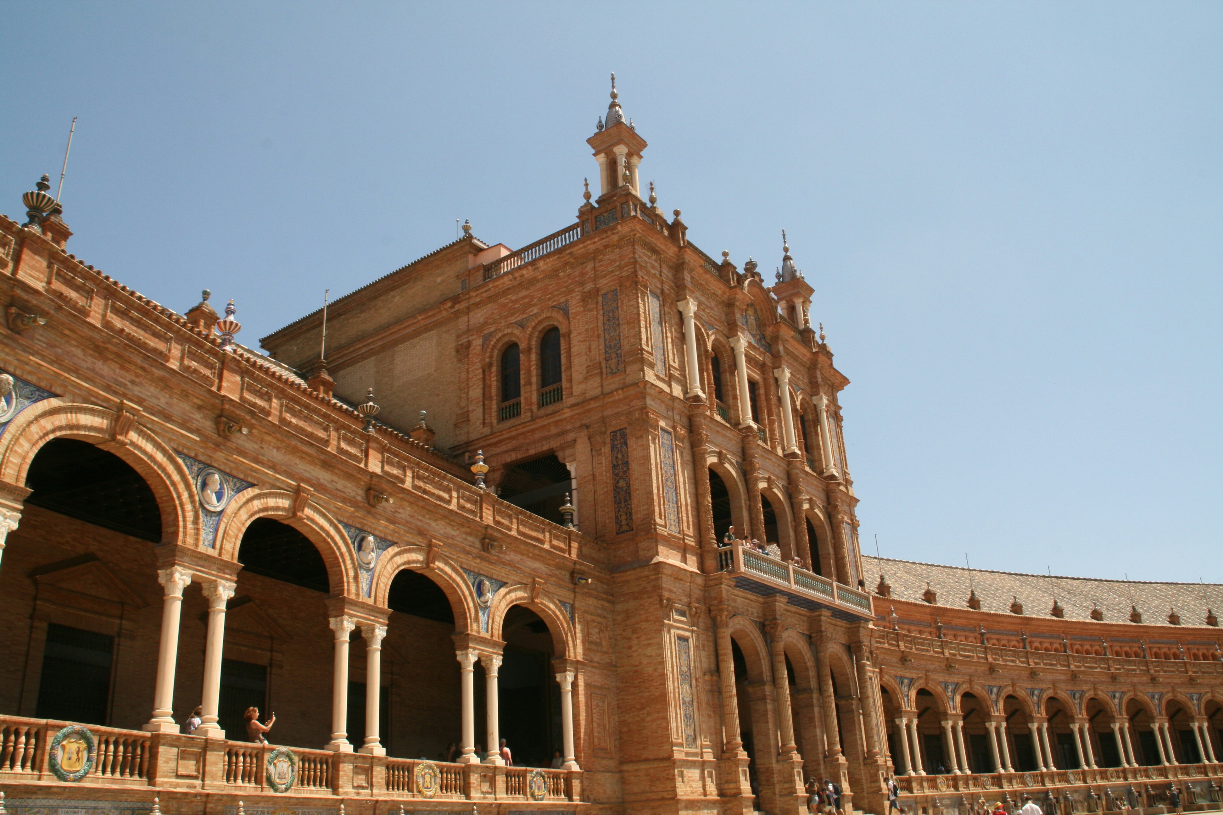 Arched Facade and Bell Tower: Sunlit Granada Courtyard