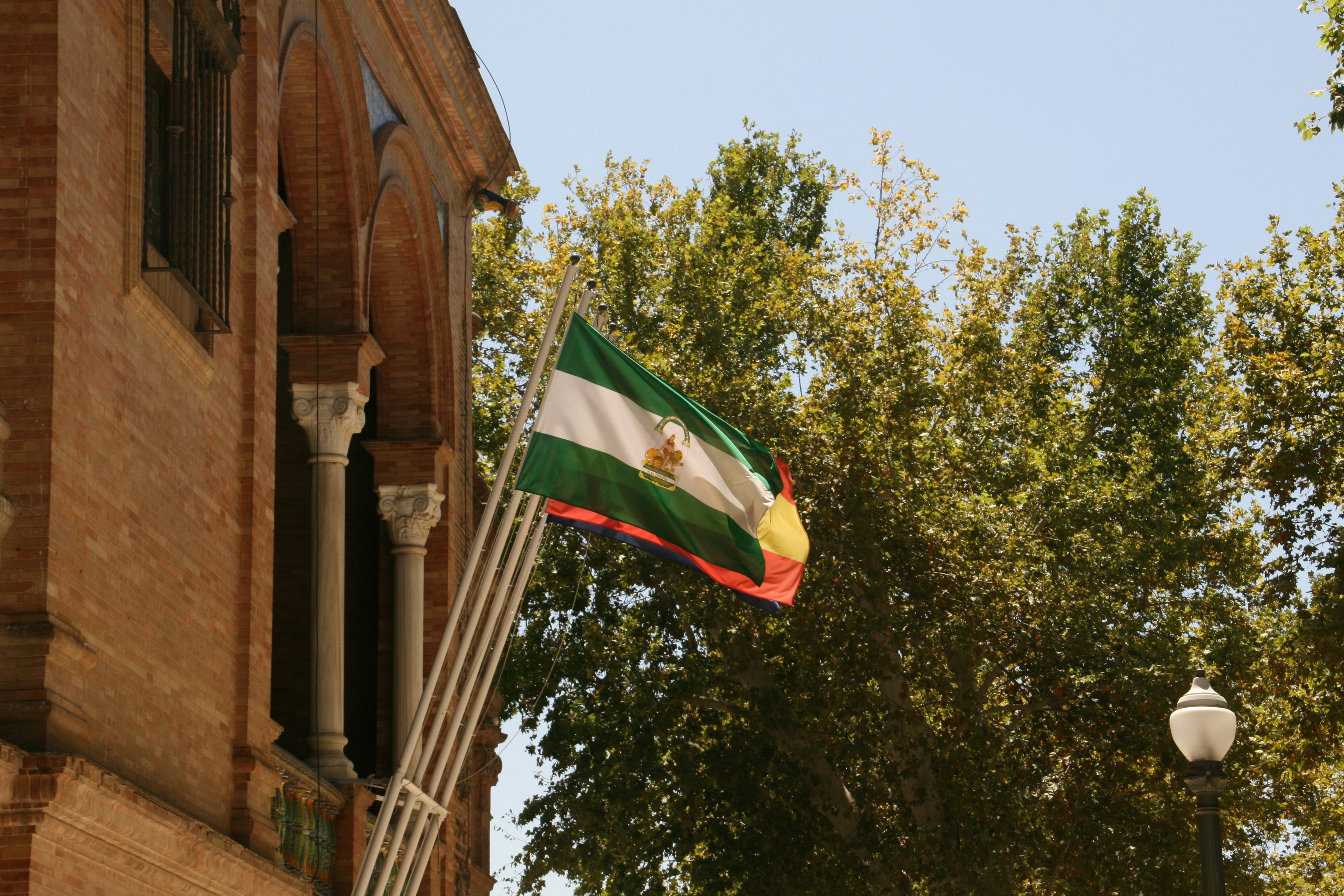 Flag in the breeze by a brick archway under a blue sky