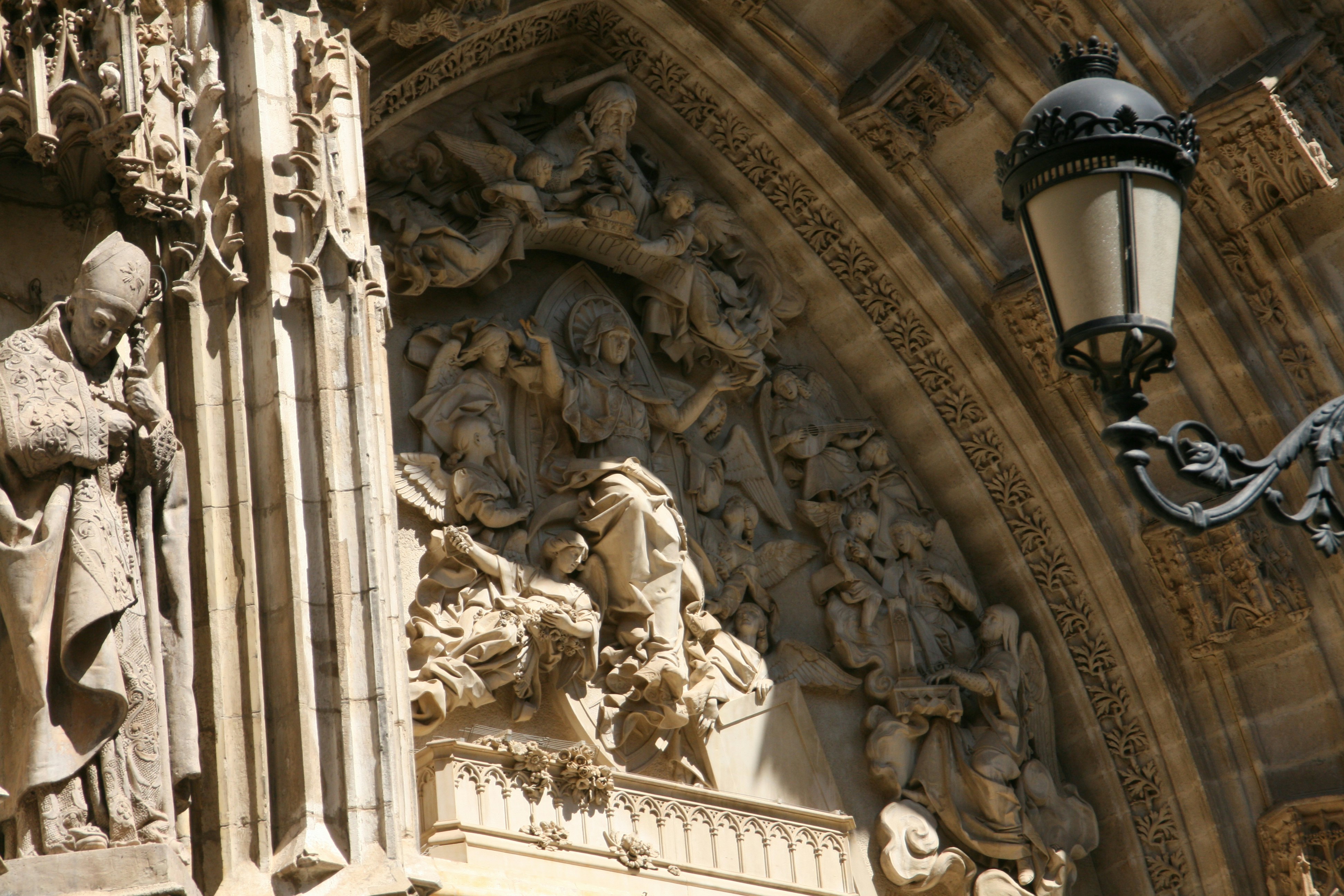 Carved carvings and streetlamp on a Gothic facade