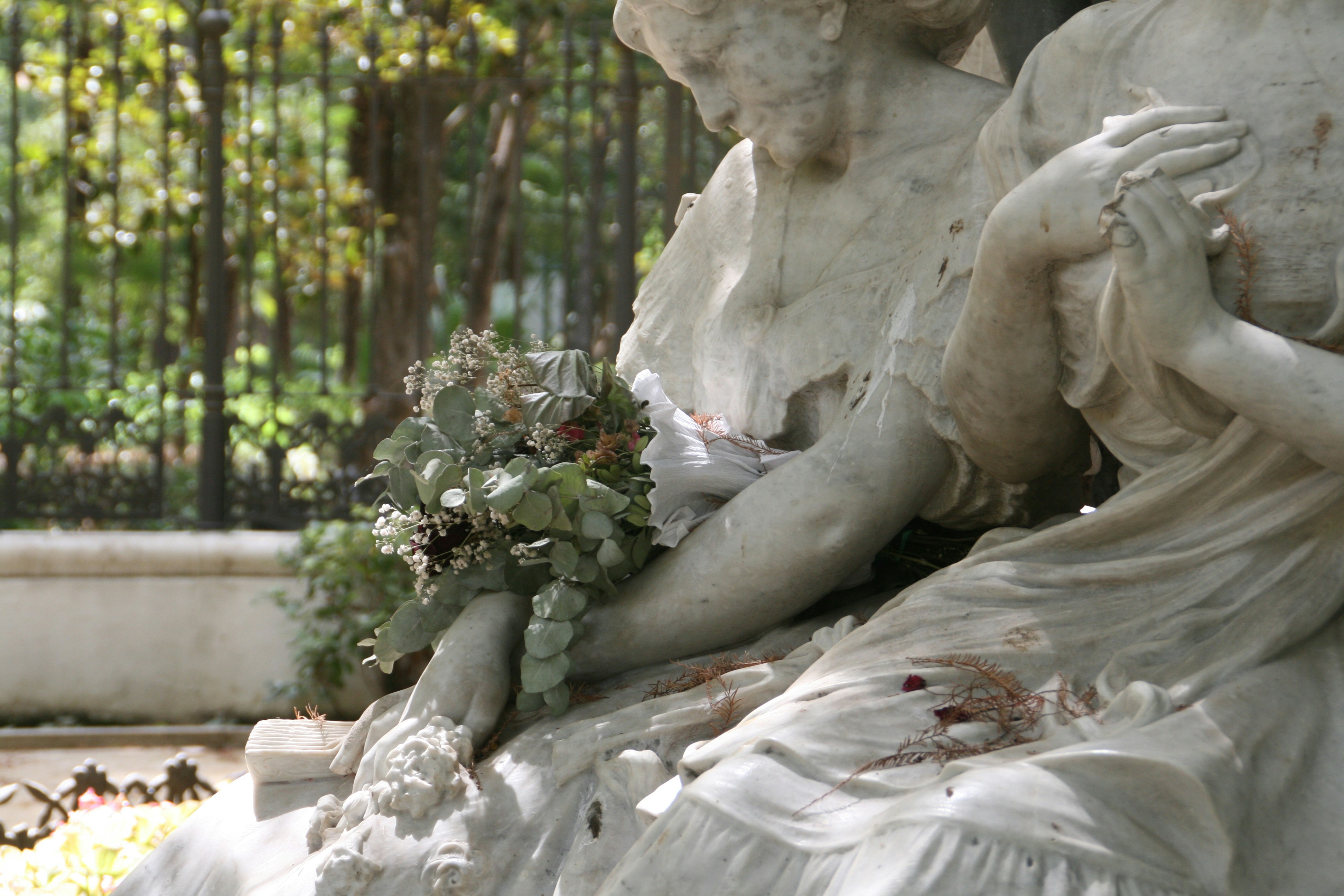 Silent Petals: A Weathered Marble Embrace in the Garden