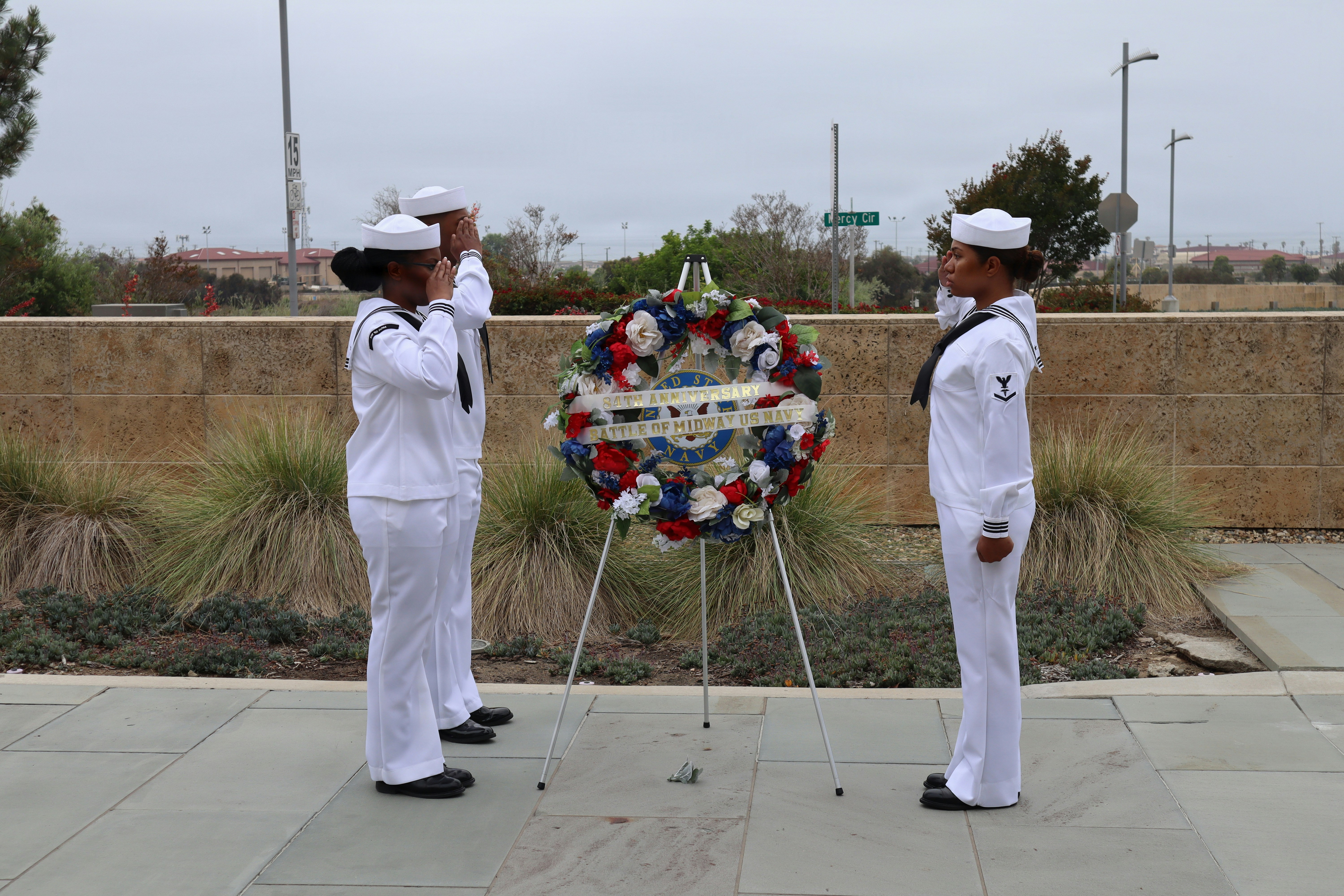 Ceremonial Honor: Sailors paying respects beside the wreath