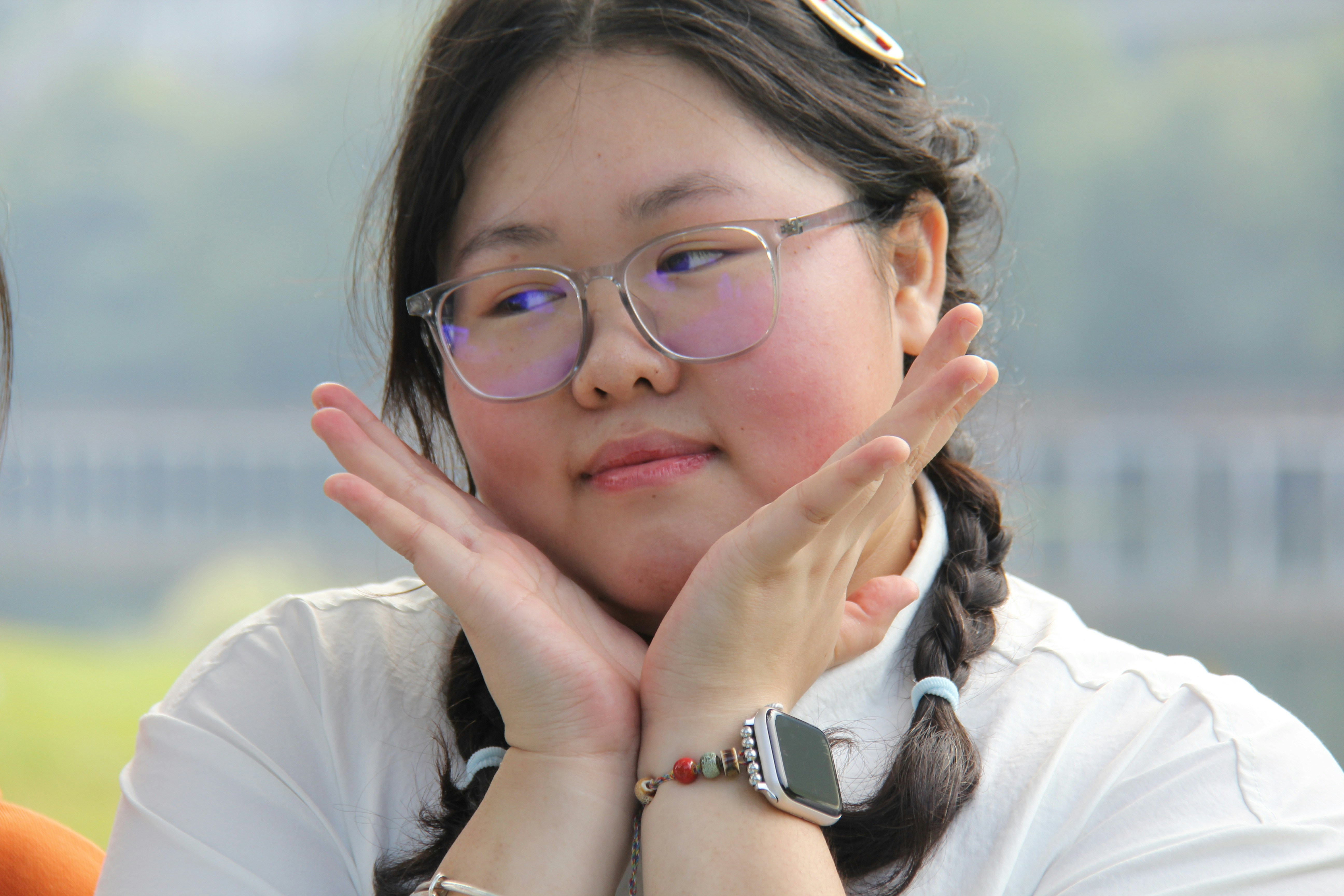 Soft Poise: A contemplative portrait with hands framing the face