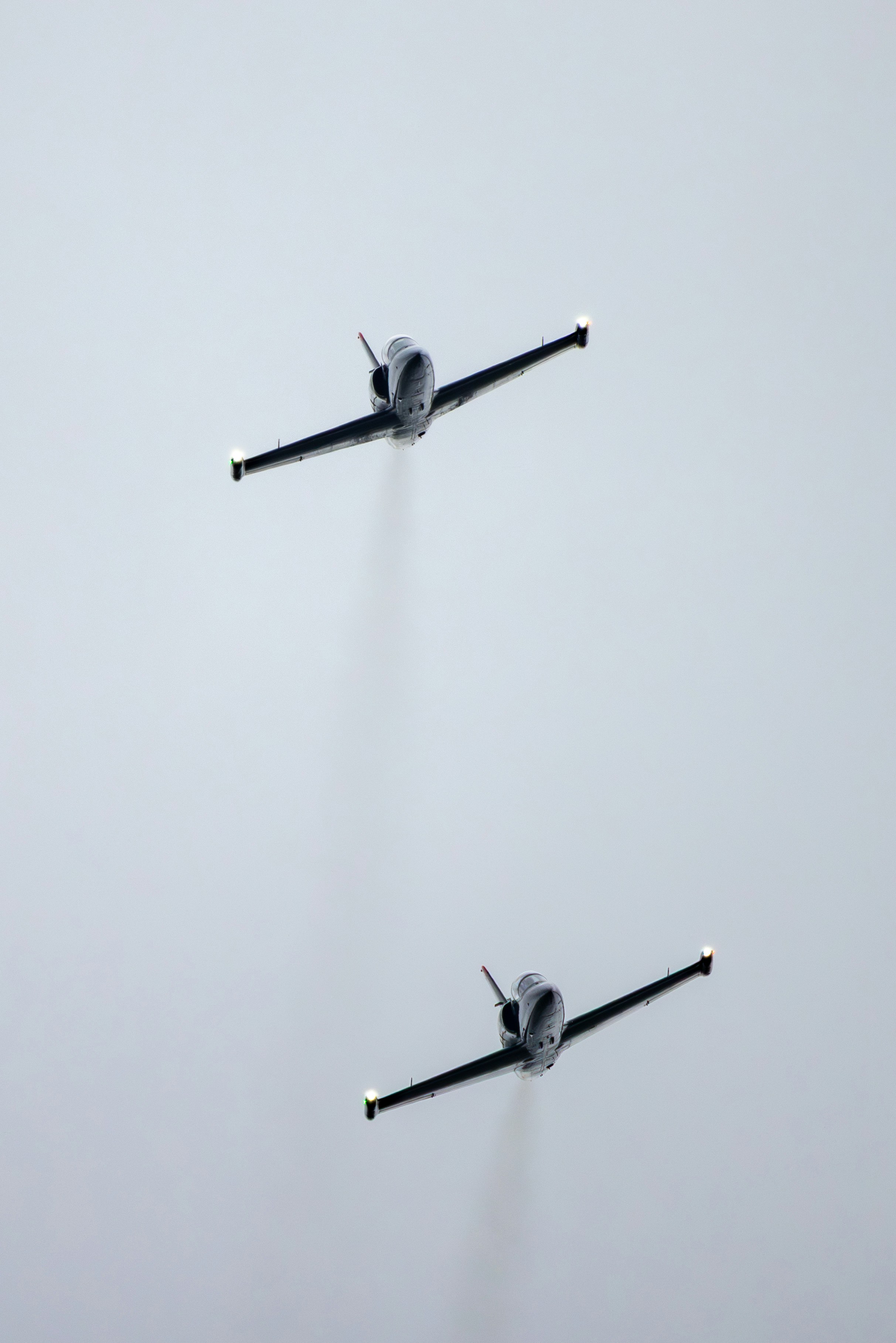 Twin-Tail Aircrafts in Aerial Backlit Drift