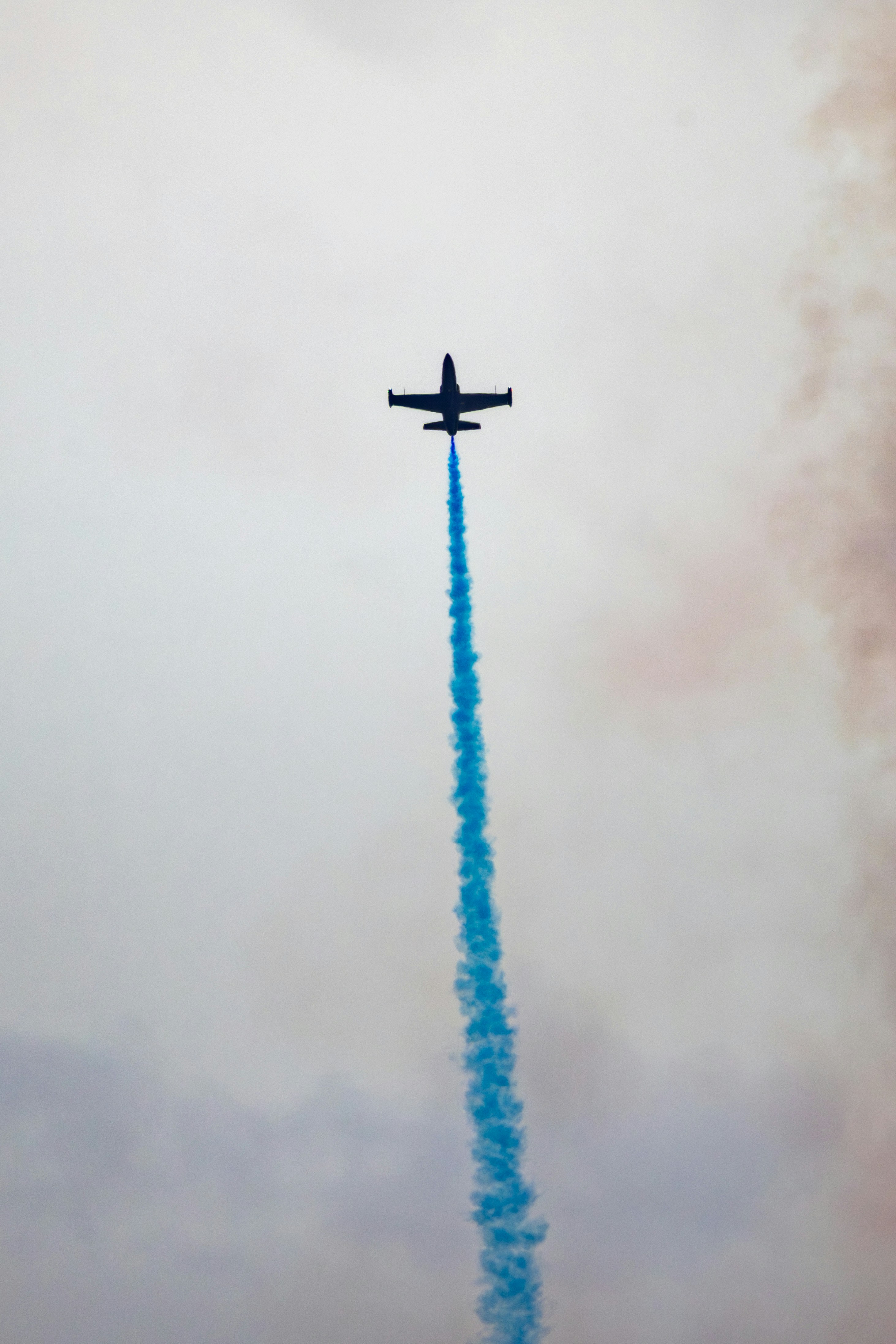 Trailing Blue Summit: A Plane Piercing the Sky