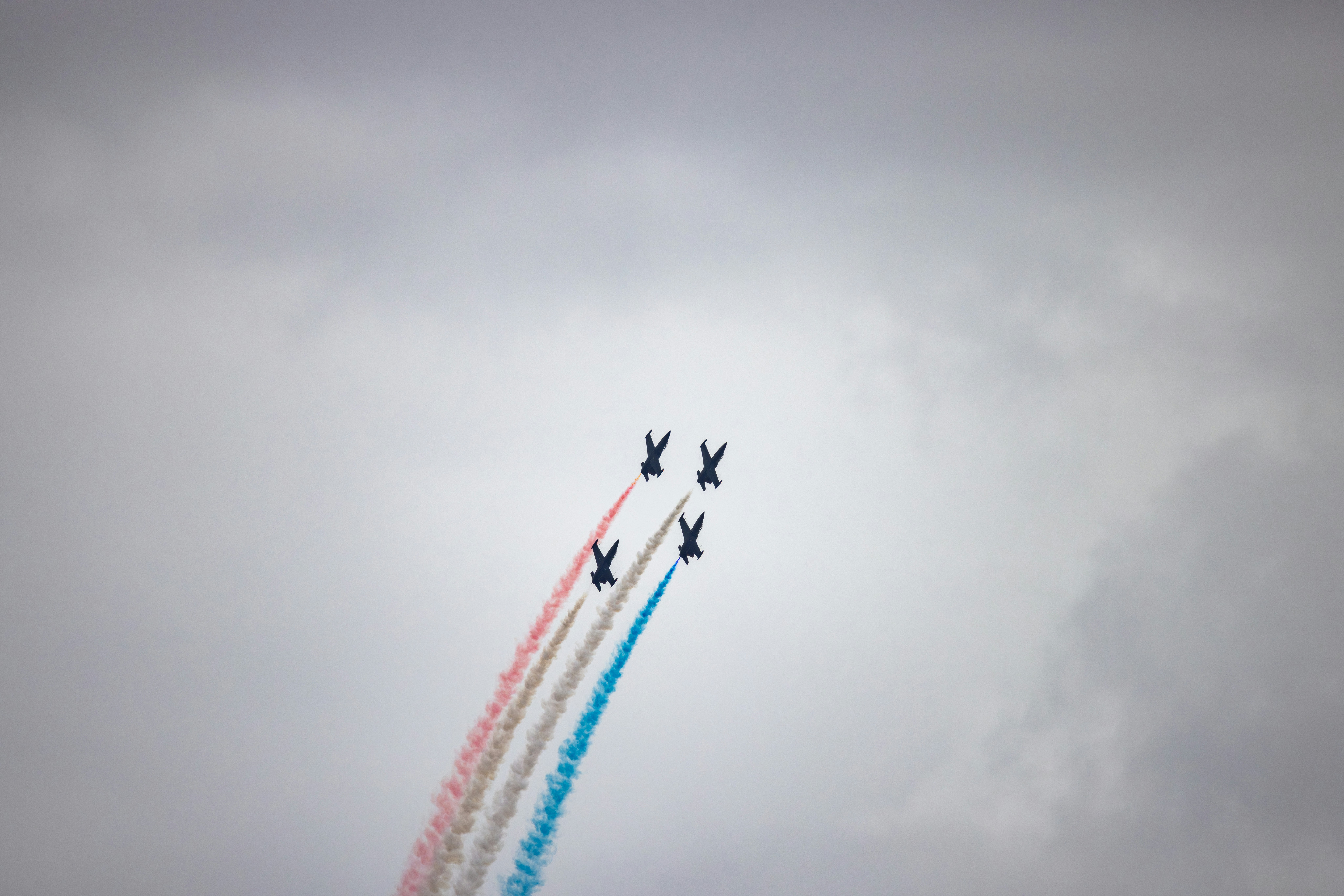 Trio of Colorful Contrails: Aerial Acrobats in Sync