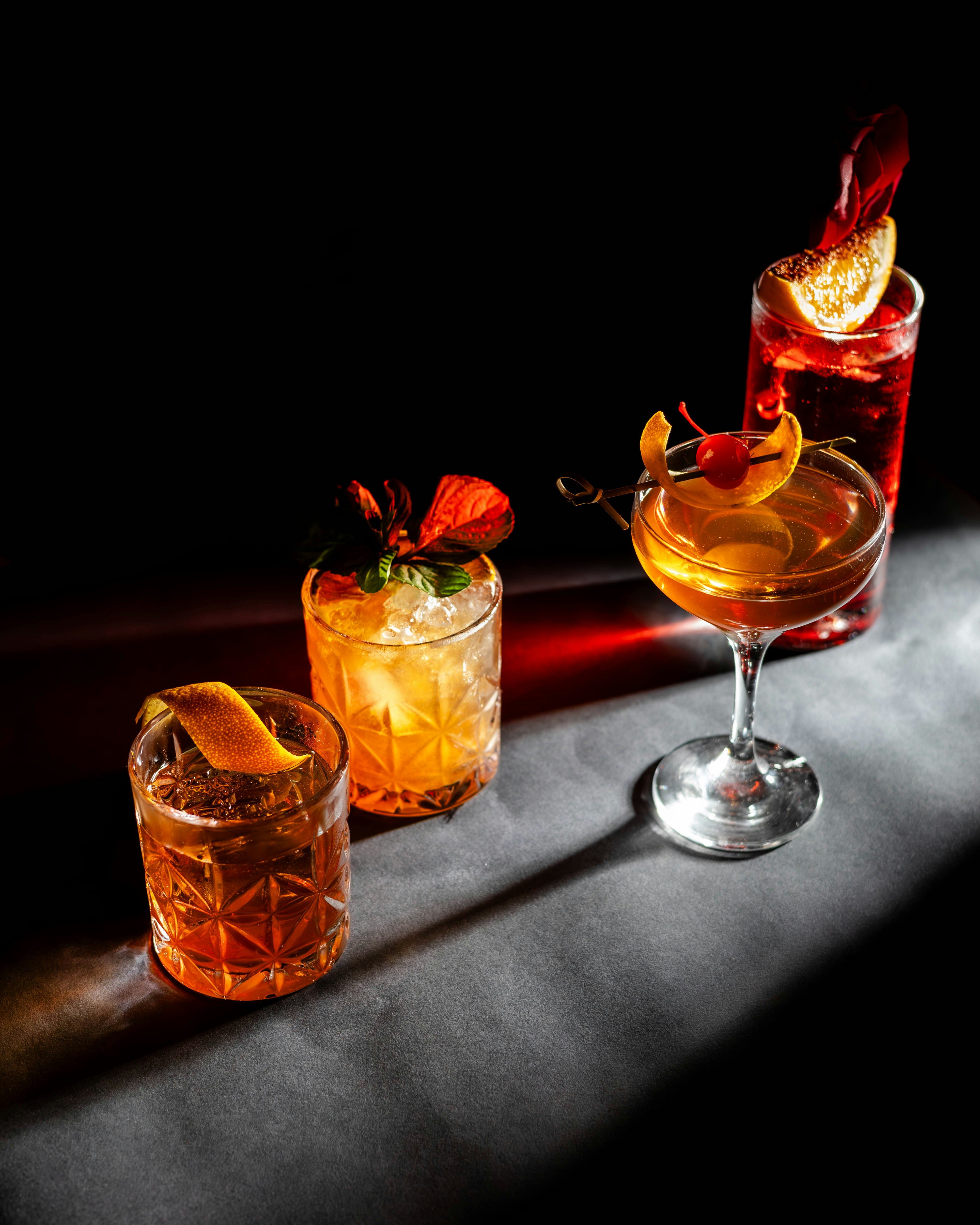 Glowing Cocktail Row: A Trio of Spirits in Midnight Light