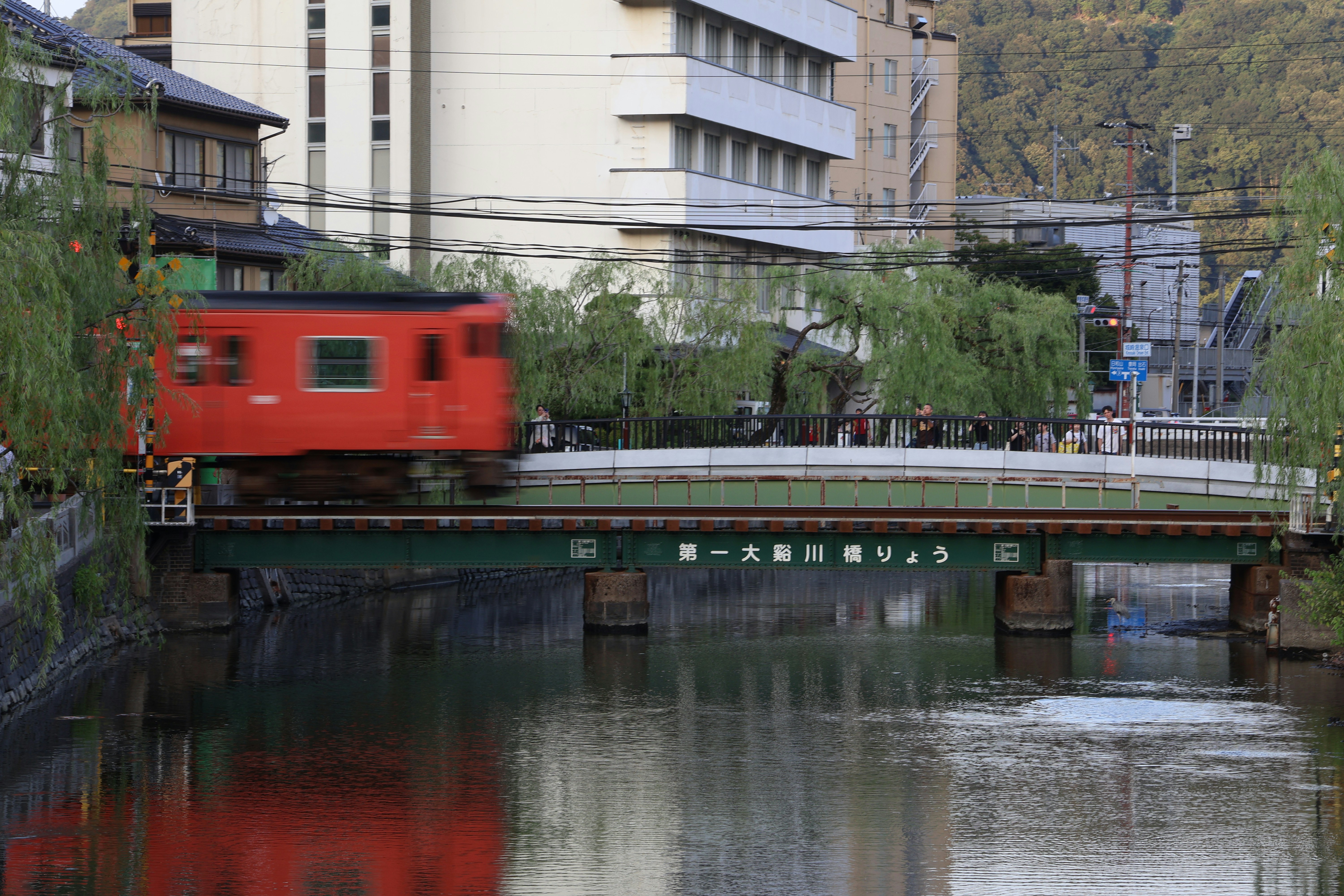 The San-in Main line passes on a local bridge in Kinosaki Onsen.