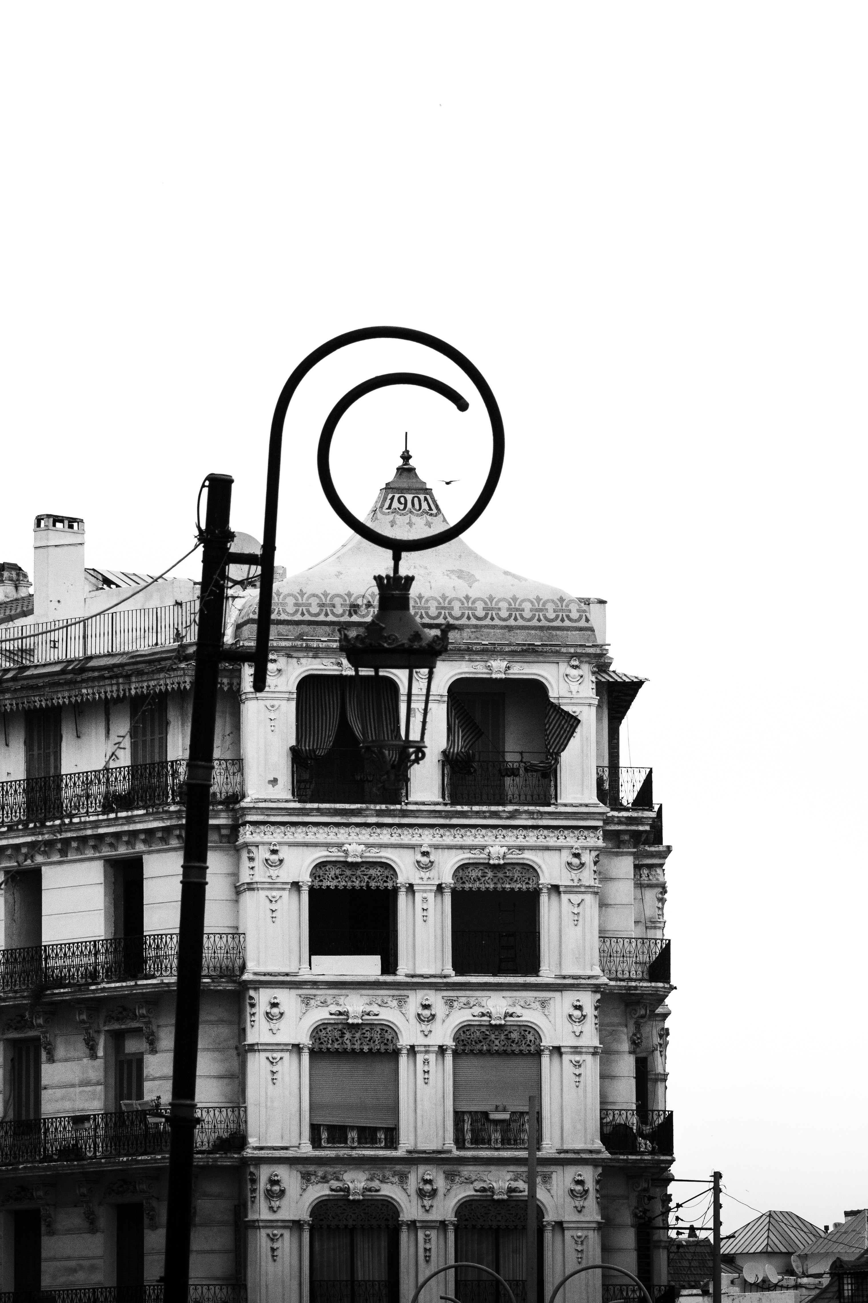 Ornate Facade under a Circular Streetlamp