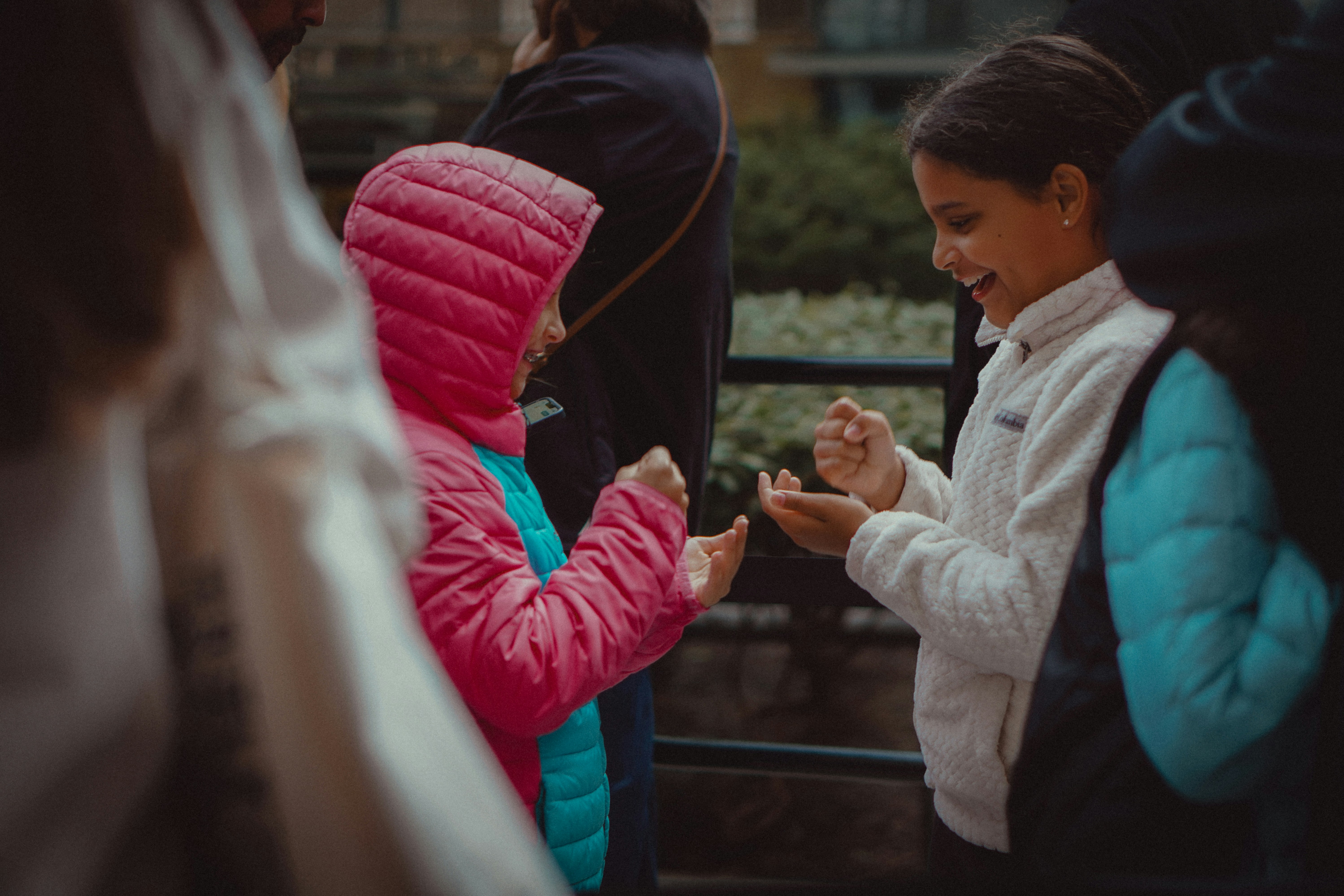 Hands In Dialogue: a cheerful exchange among friends on a park railing